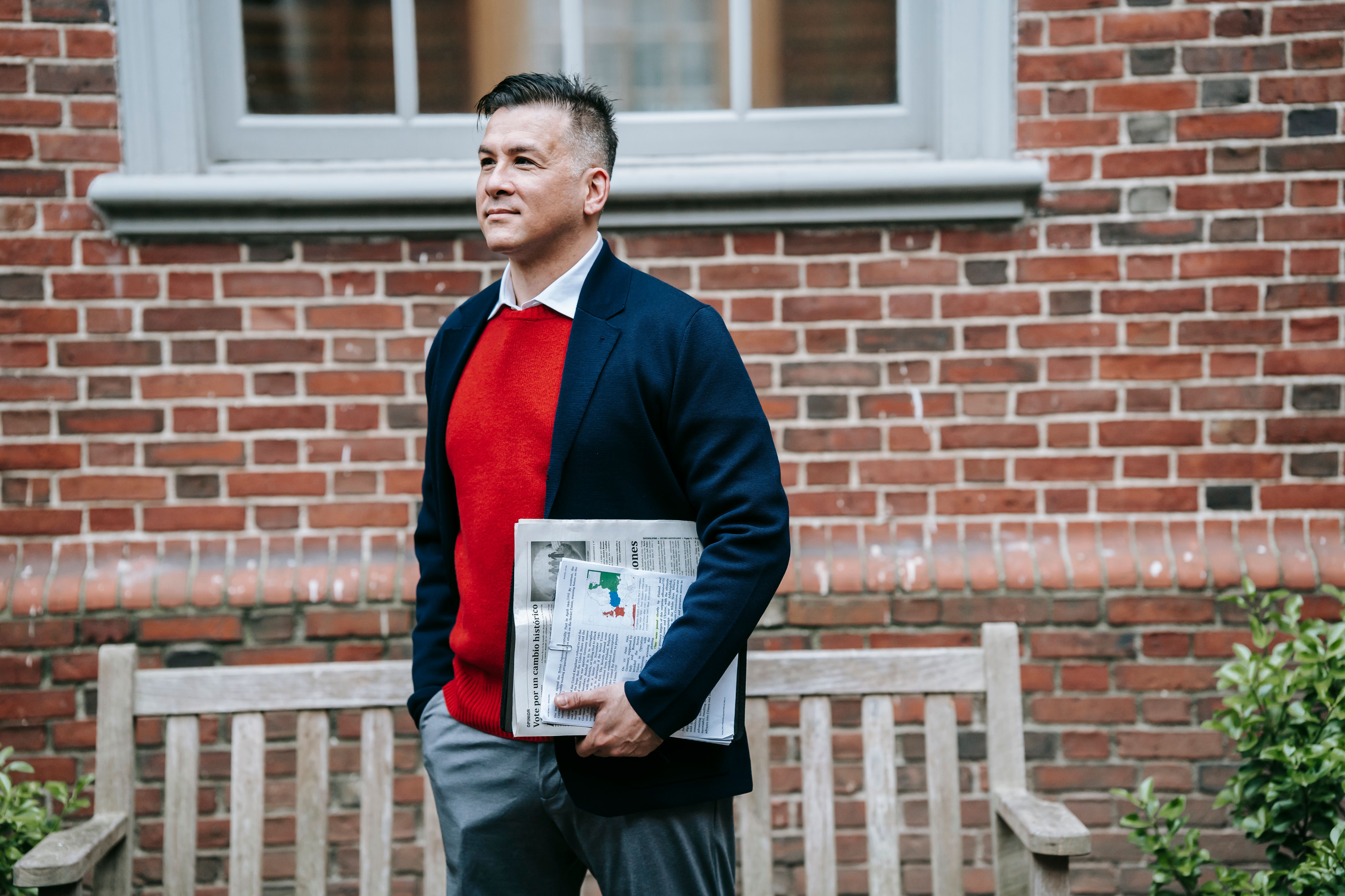 Photo Of Man Standing In Front Of Wooden Bench · Free Stock Photo