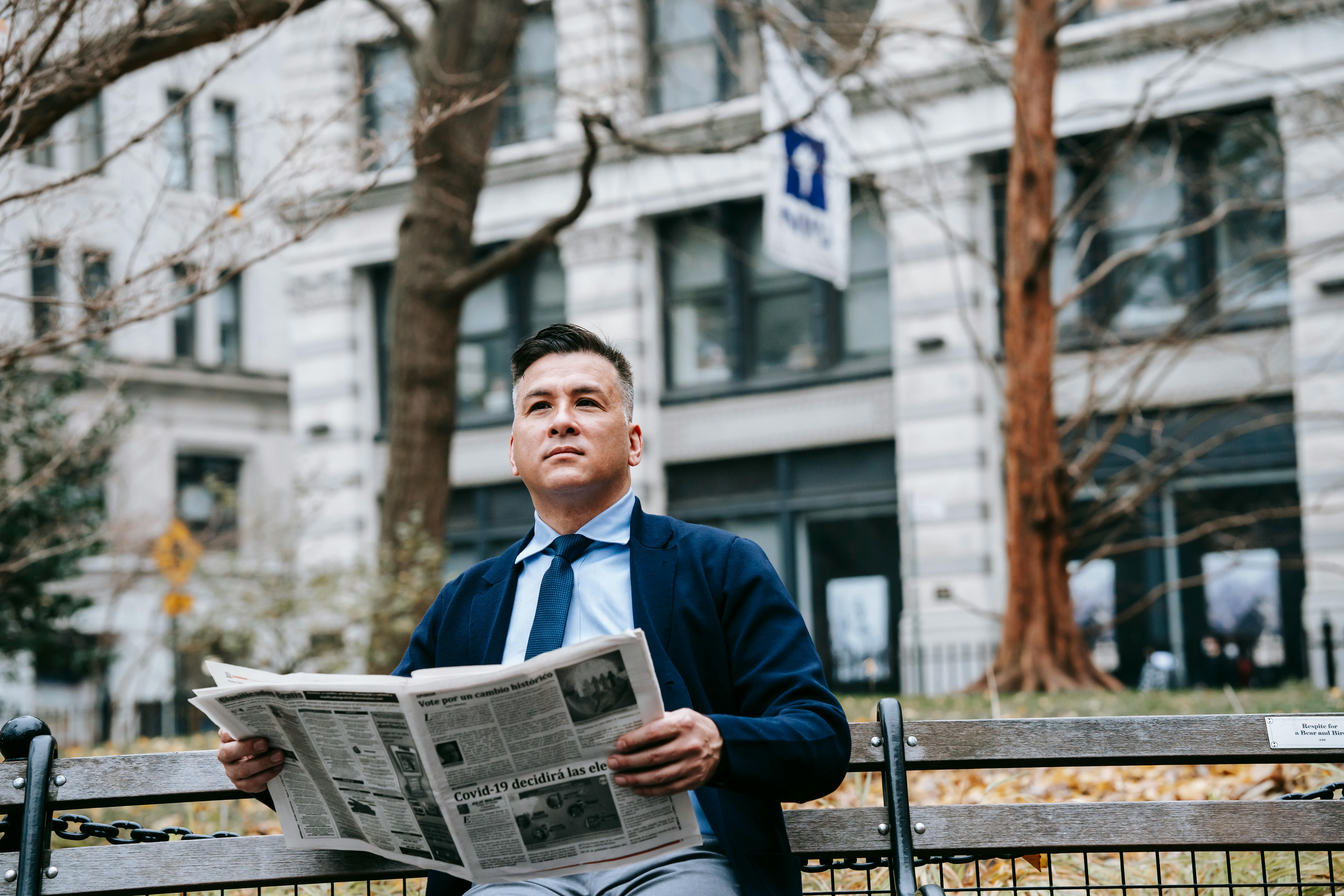 Photo Of Man Holding Newspaper · Free Stock Photo