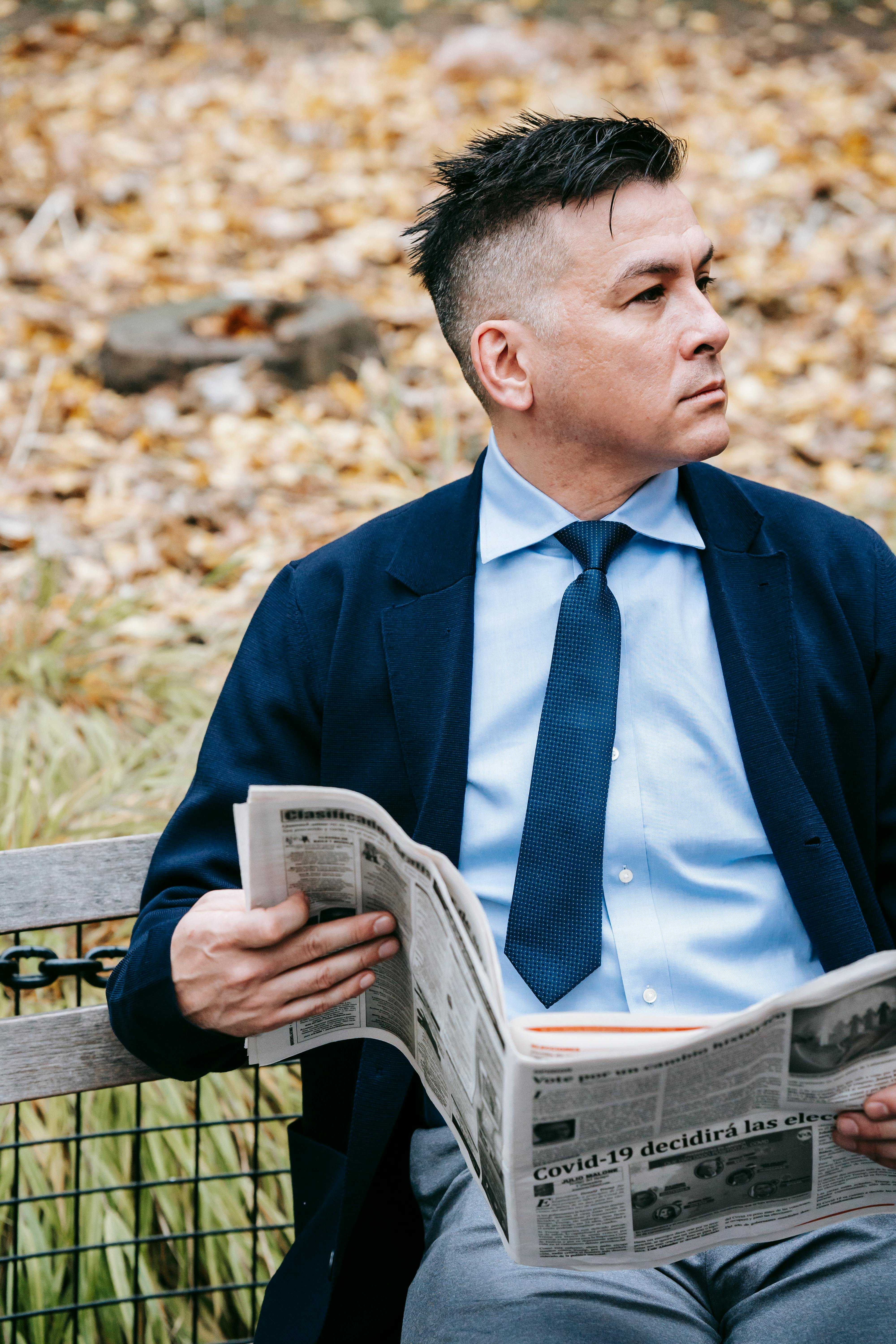 Photo Of Man Holding Newspaper · Free Stock Photo