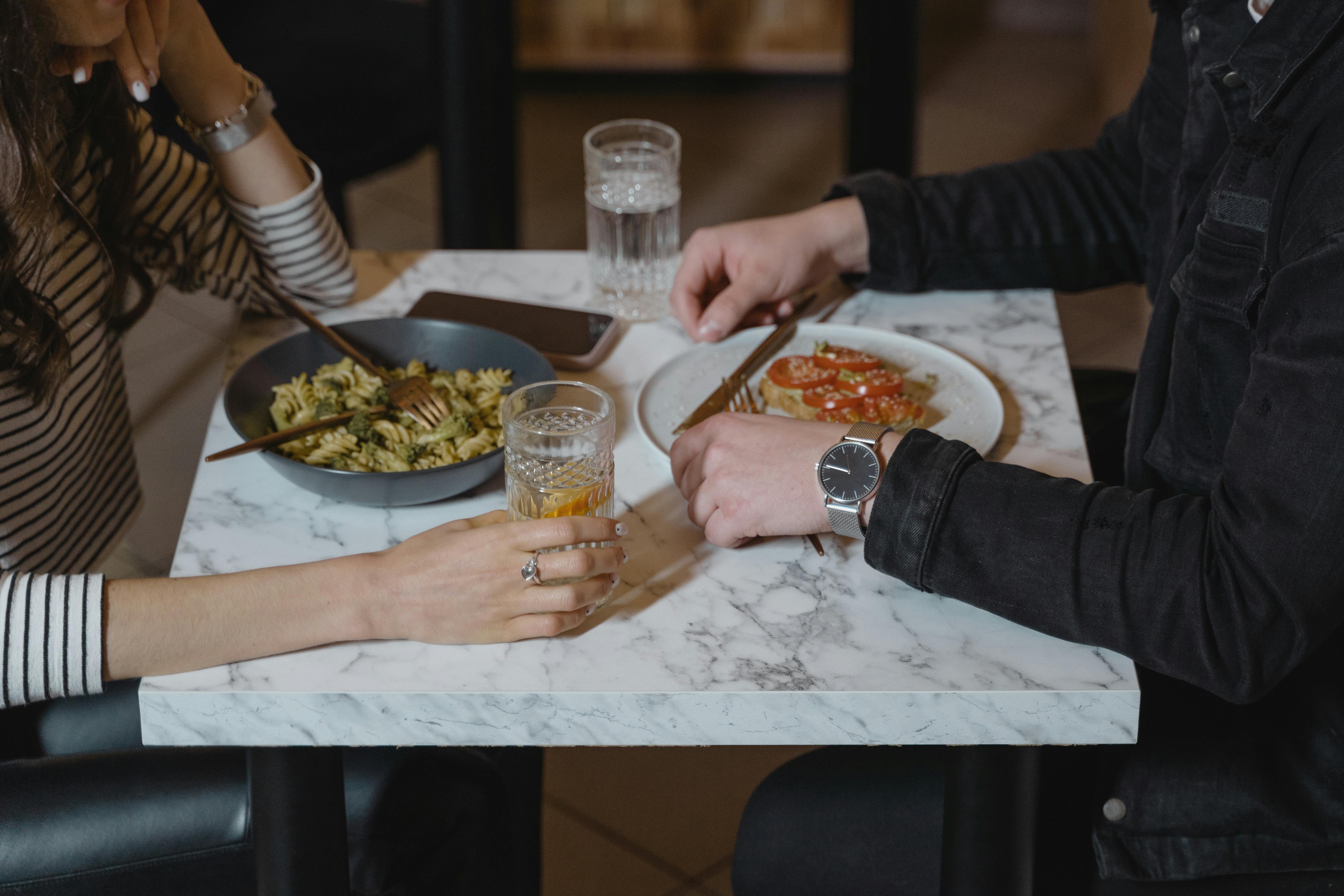 People Eating on Marble Table Top · Free Stock Photo