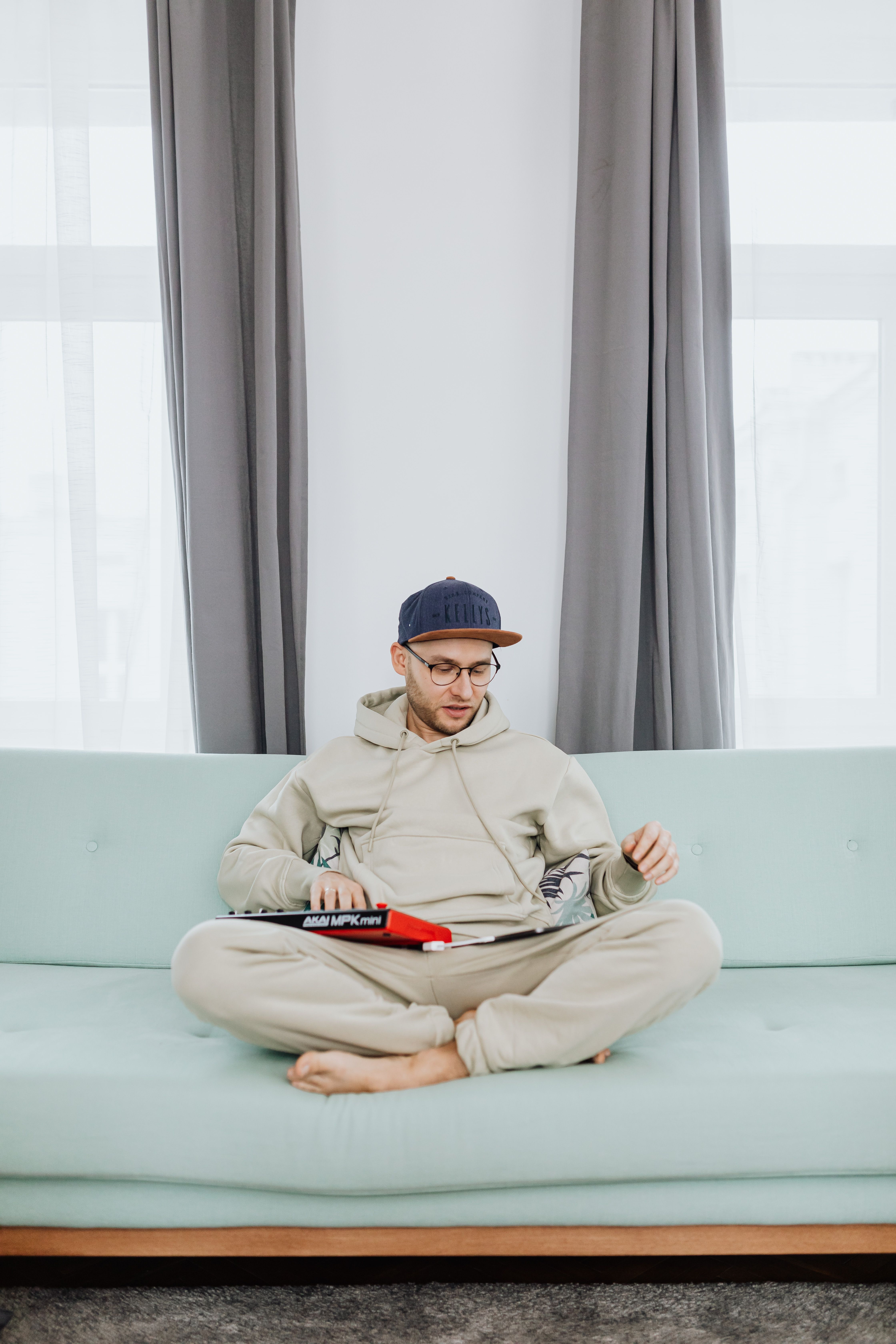 A Man in a Hoodie Using Electronic Devices · Free Stock Photo