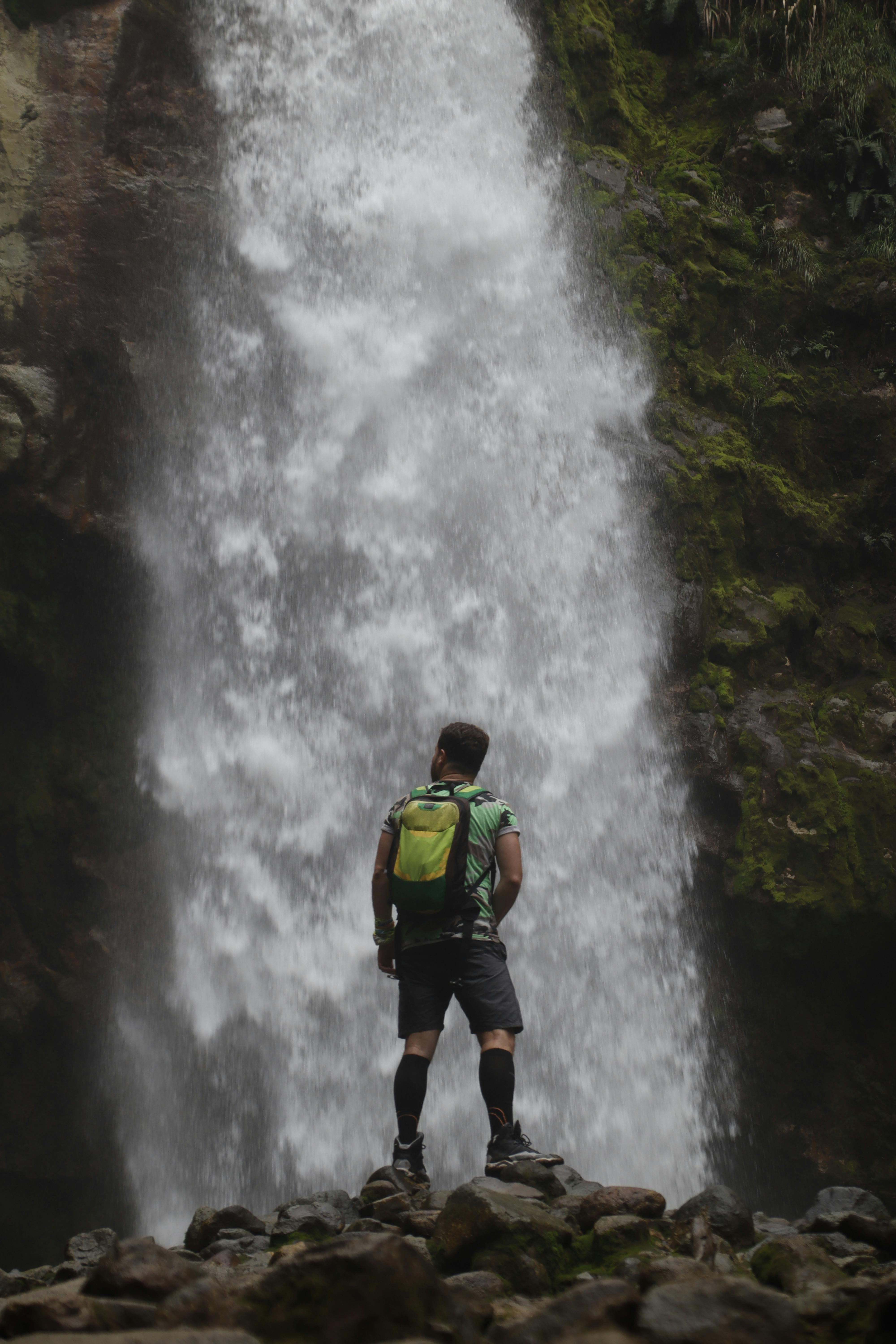 A Man Standing in Front of Waterfall · Free Stock Photo
