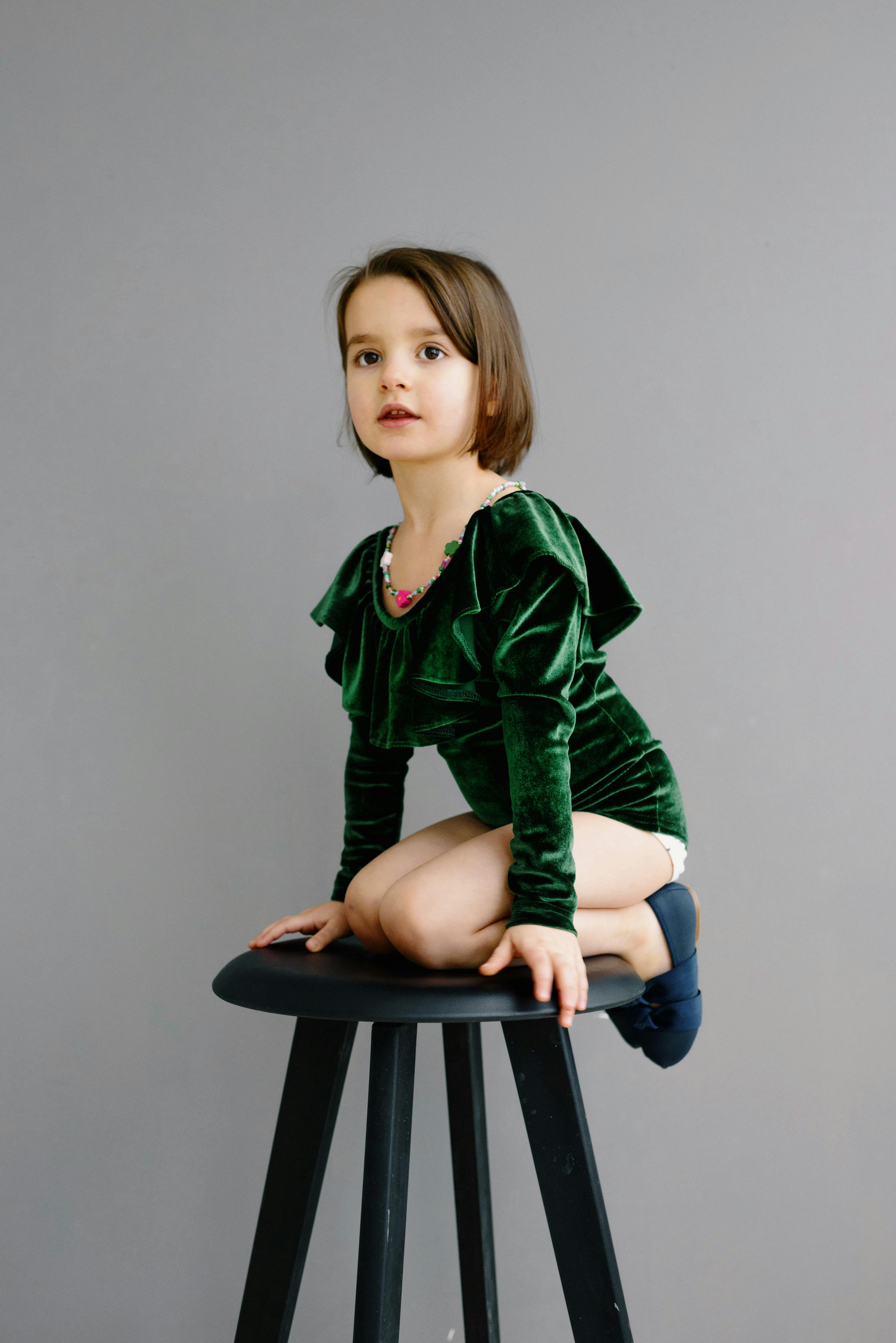 Child Model Posing on Stool · Free Stock Photo