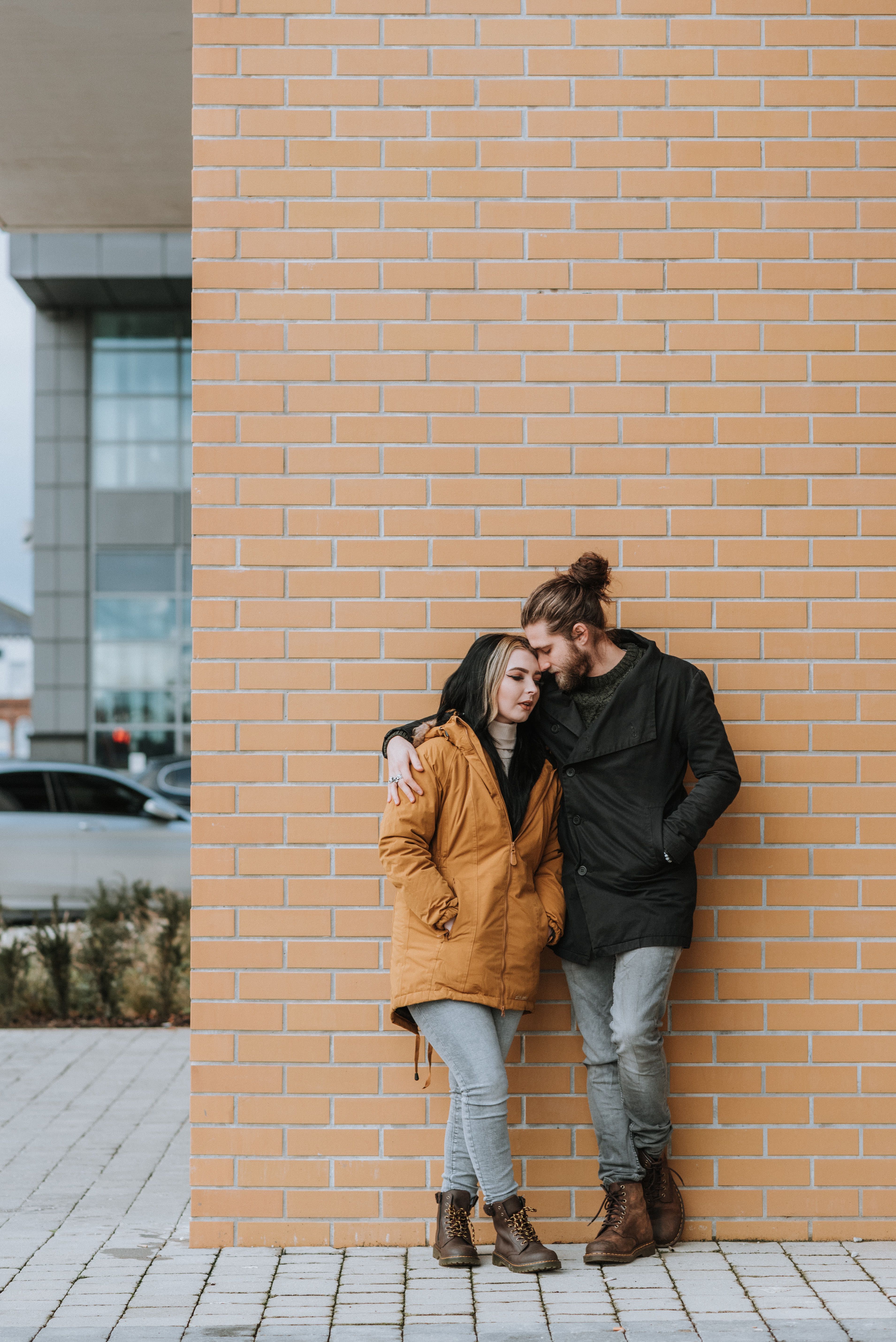 Loving young couple cuddling on street · Free Stock Photo