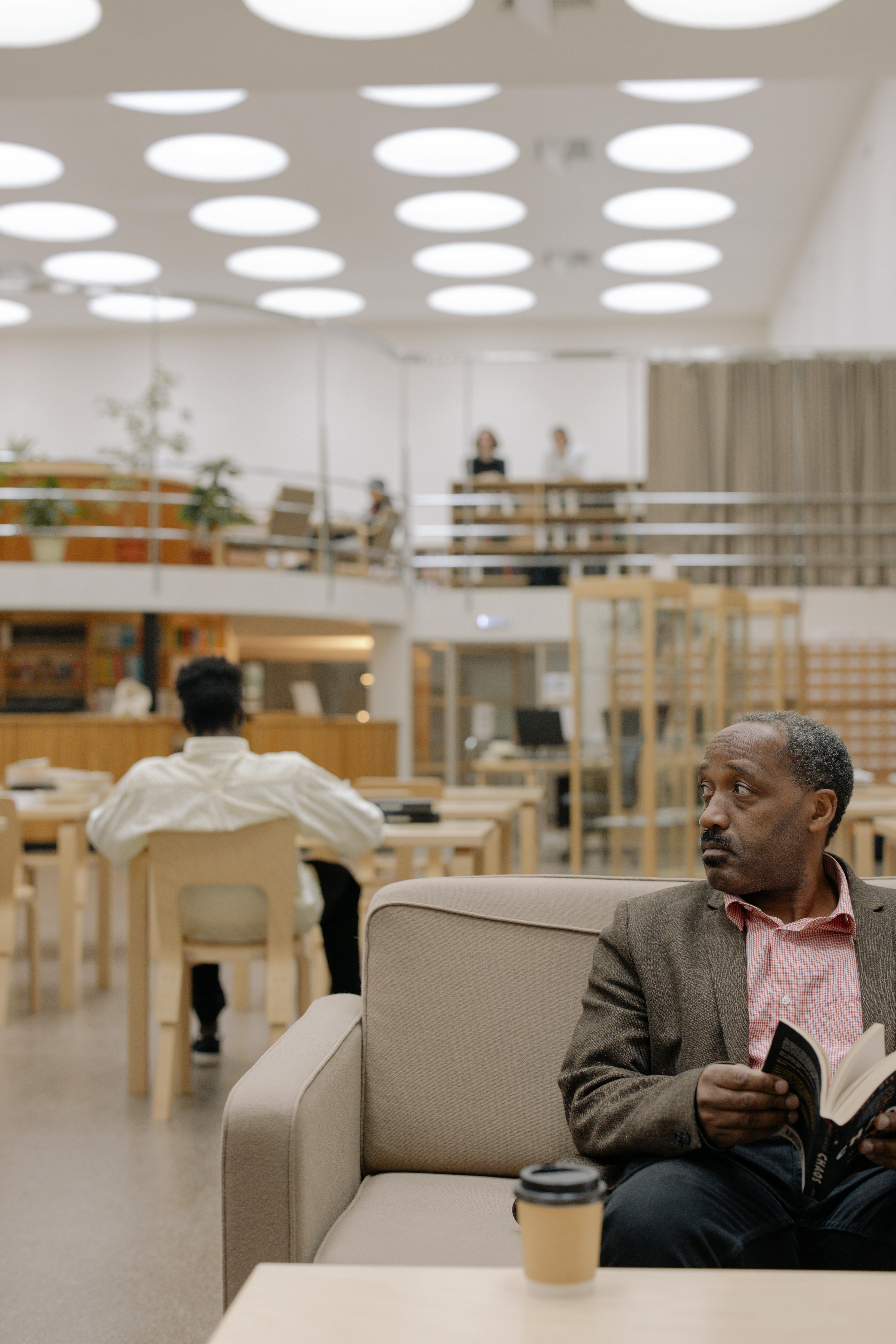 People at Library Sitting Down at Tables · Free Stock Photo