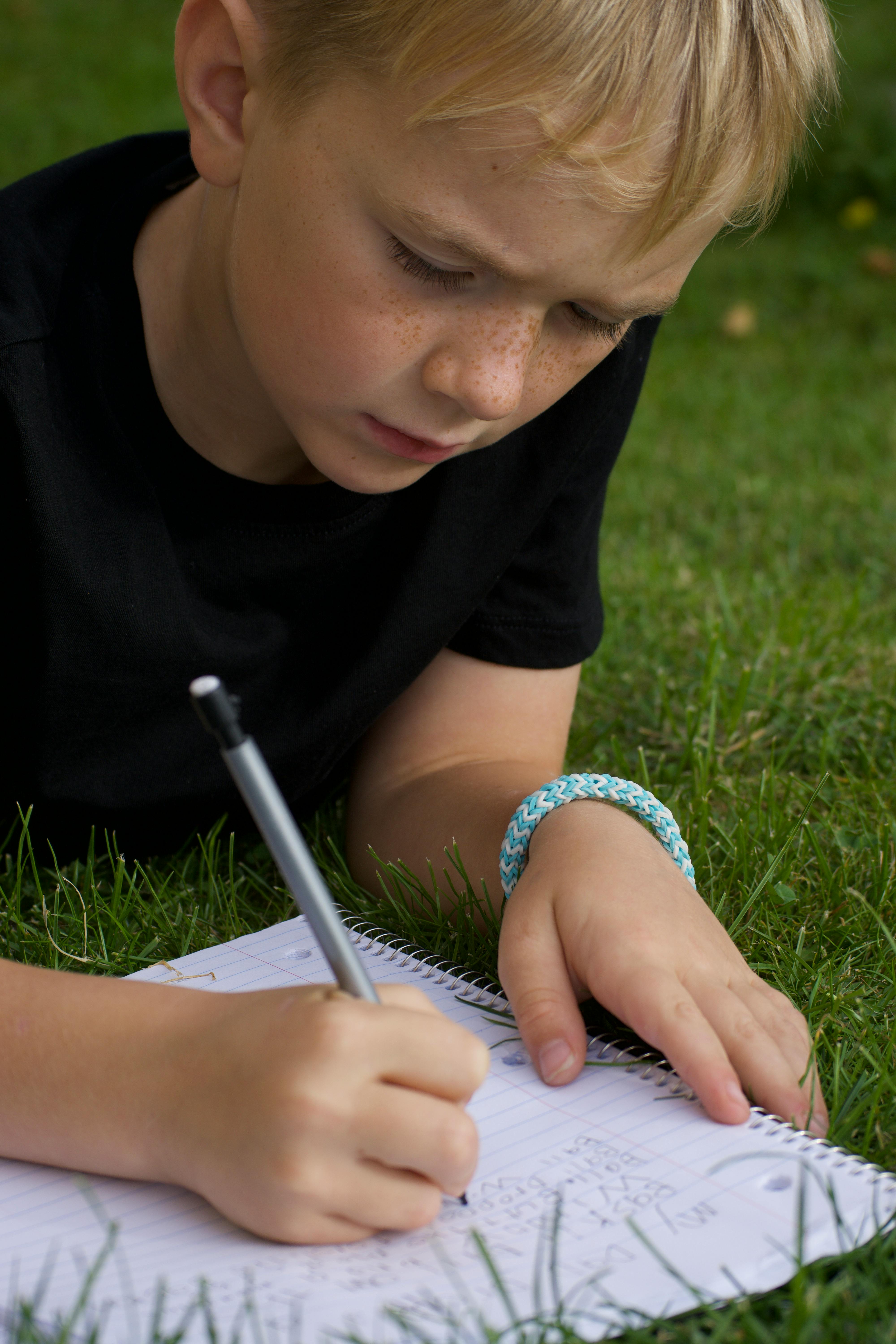 A Kid Doing His Assignment · Free Stock Photo