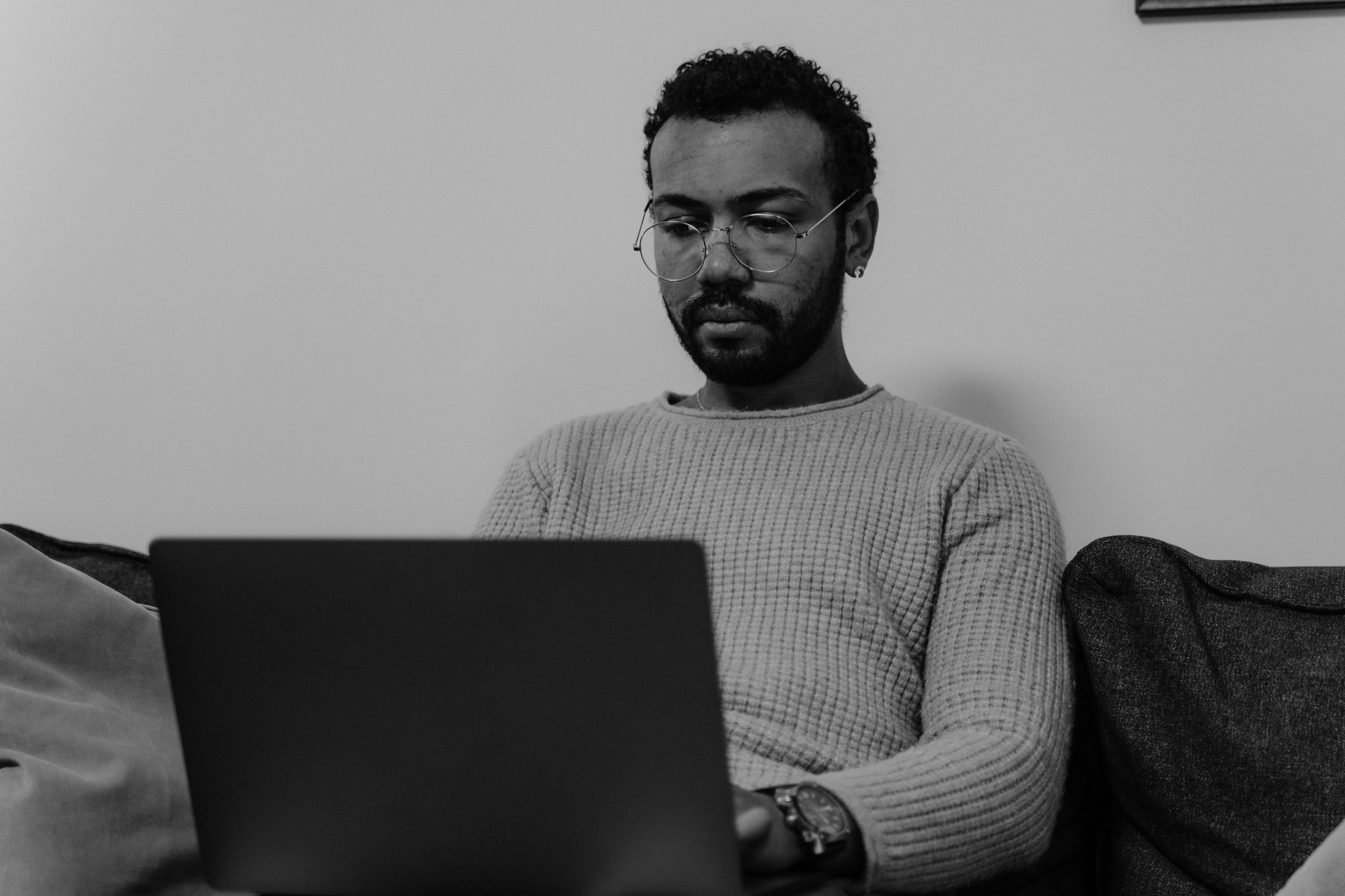 Grayscale Photography of a Man in Sweater Using Laptop Computer · Free ...