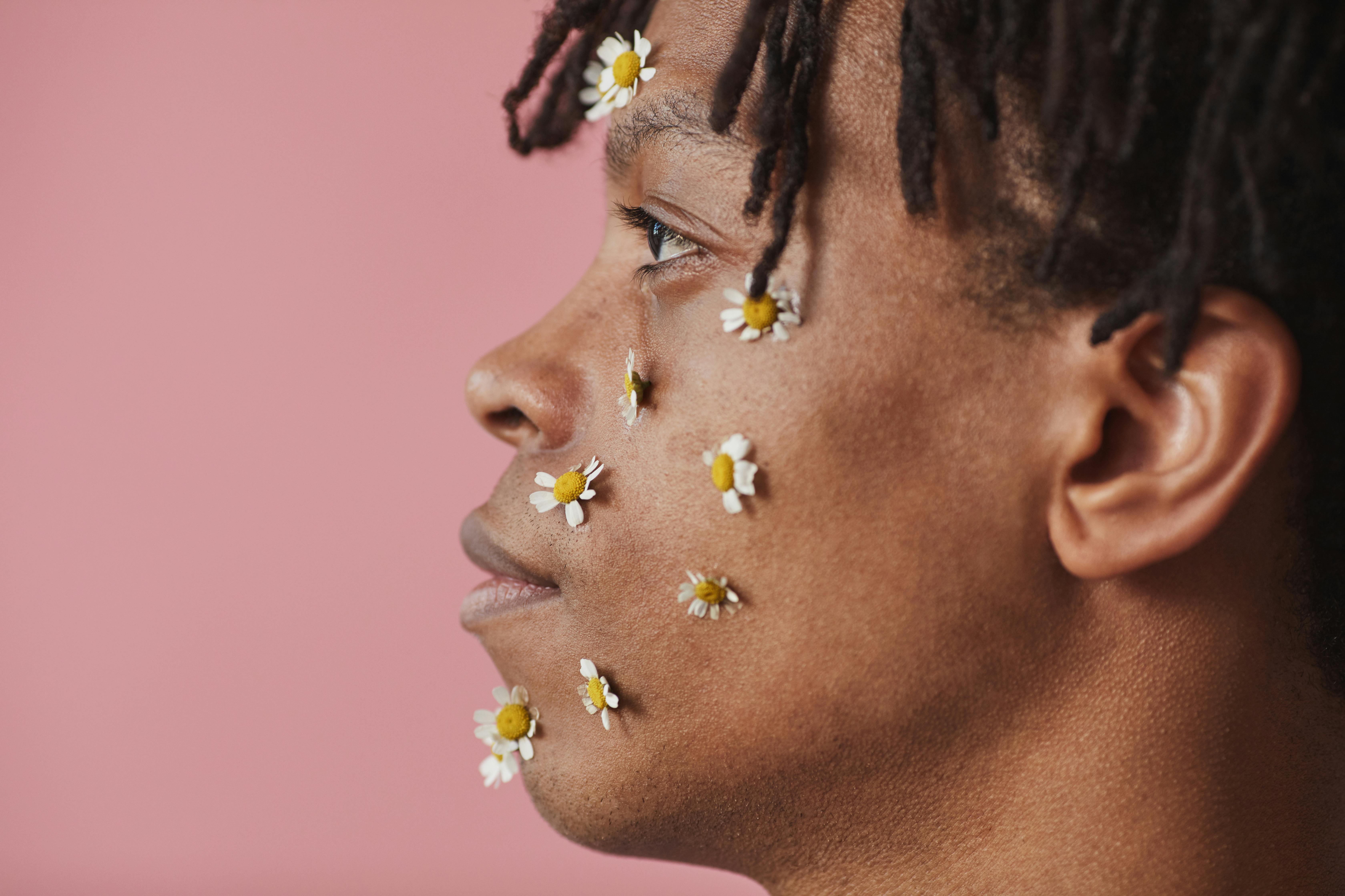 A Close-up Shot of a Man's Face with Flowers · Free Stock Photo