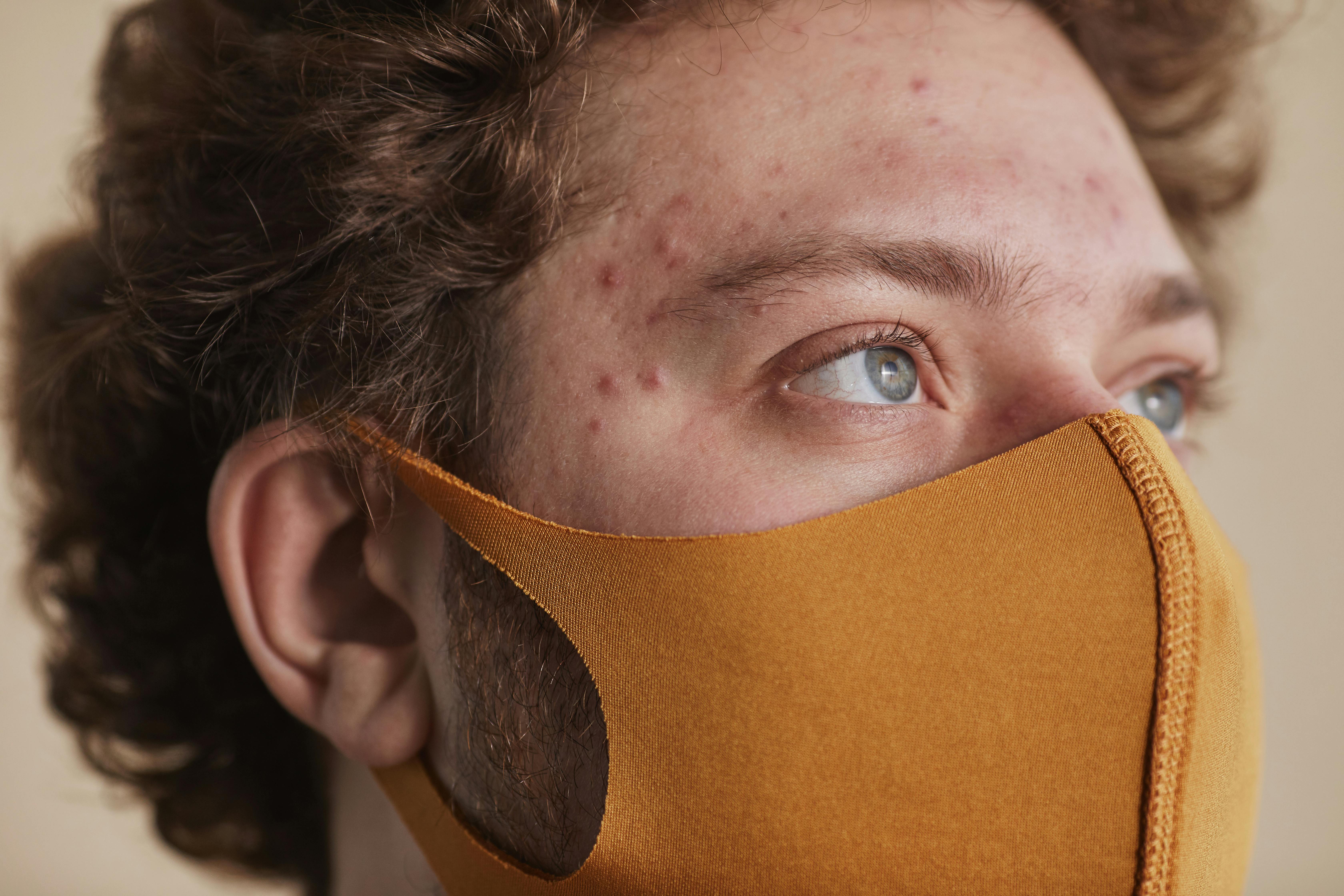 A Man Wearing a Brown Face Mask · Free Stock Photo