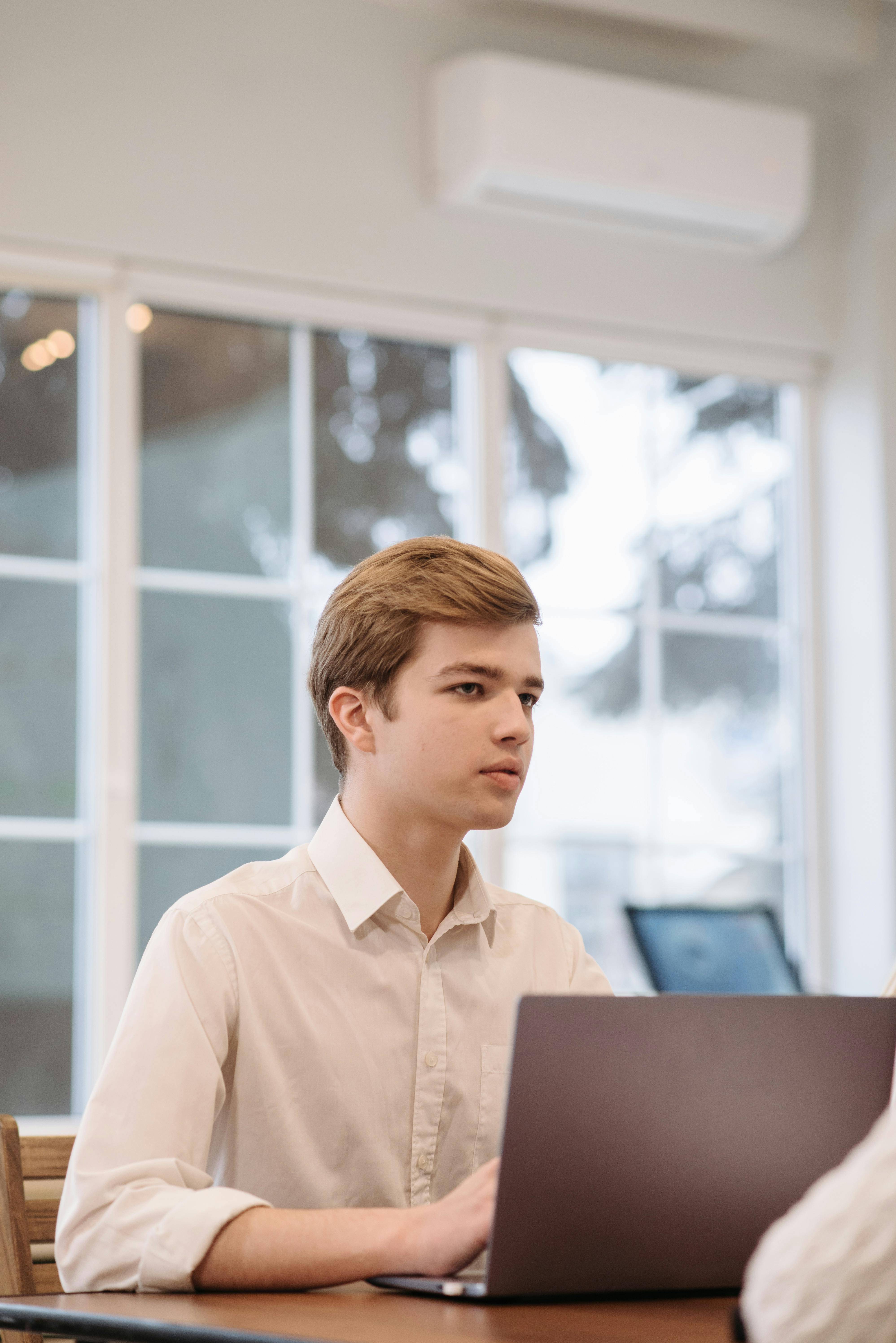 Man in White Long Sleeves Working inside the Office · Free Stock Photo