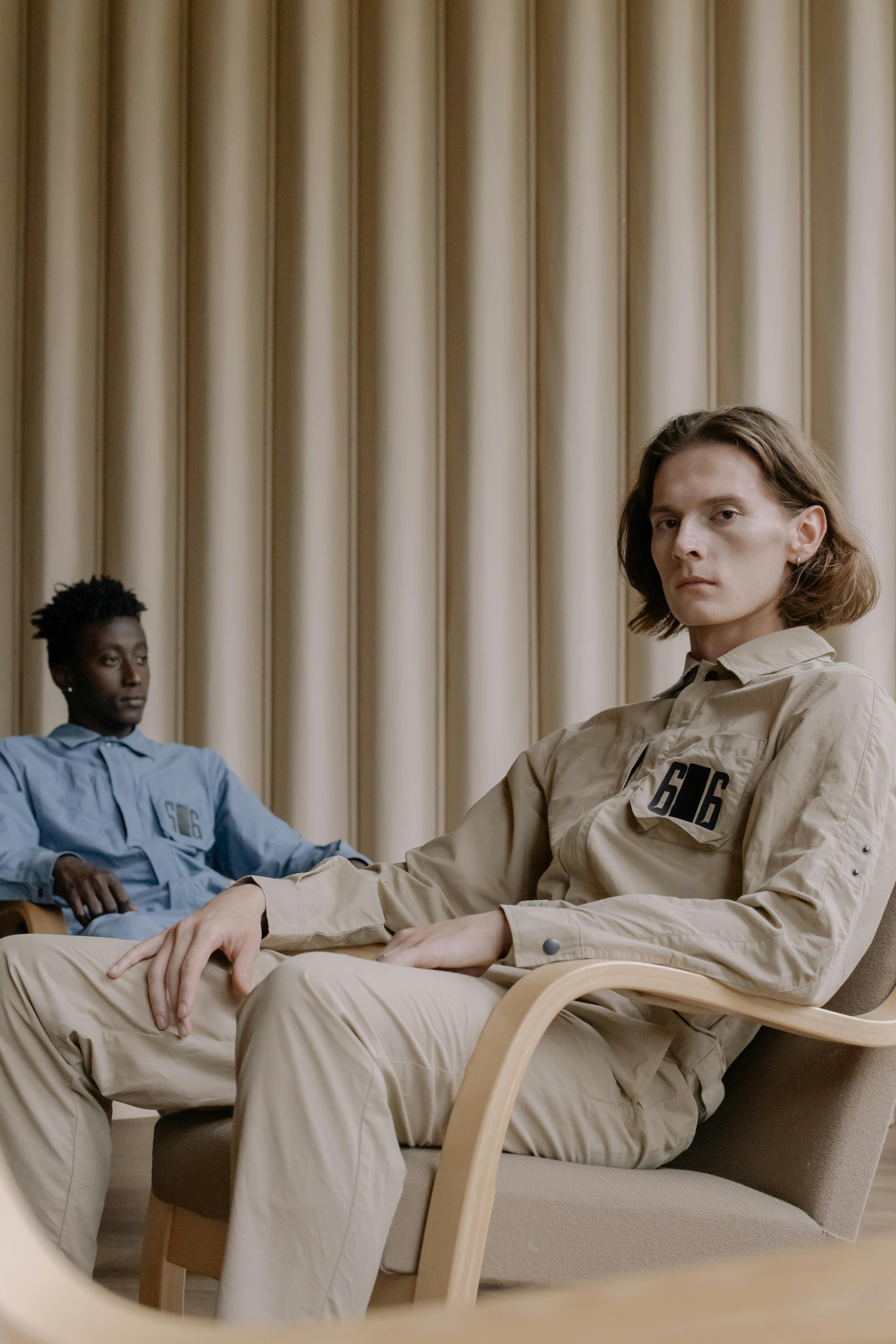 Men Overhaul Uniforms Sitting on Chairs · Free Stock Photo