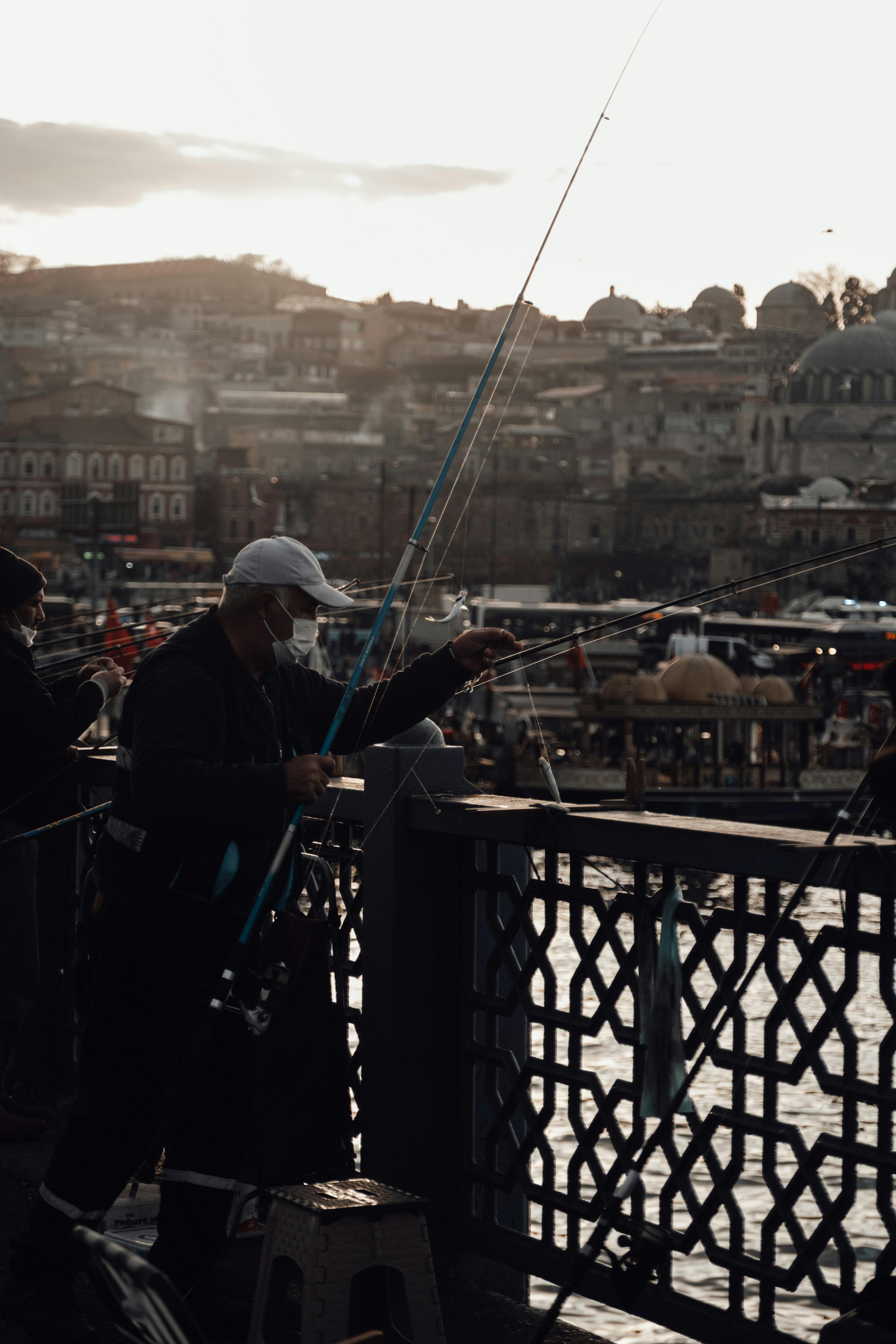 Old fishers catching fish on bridge · Free Stock Photo