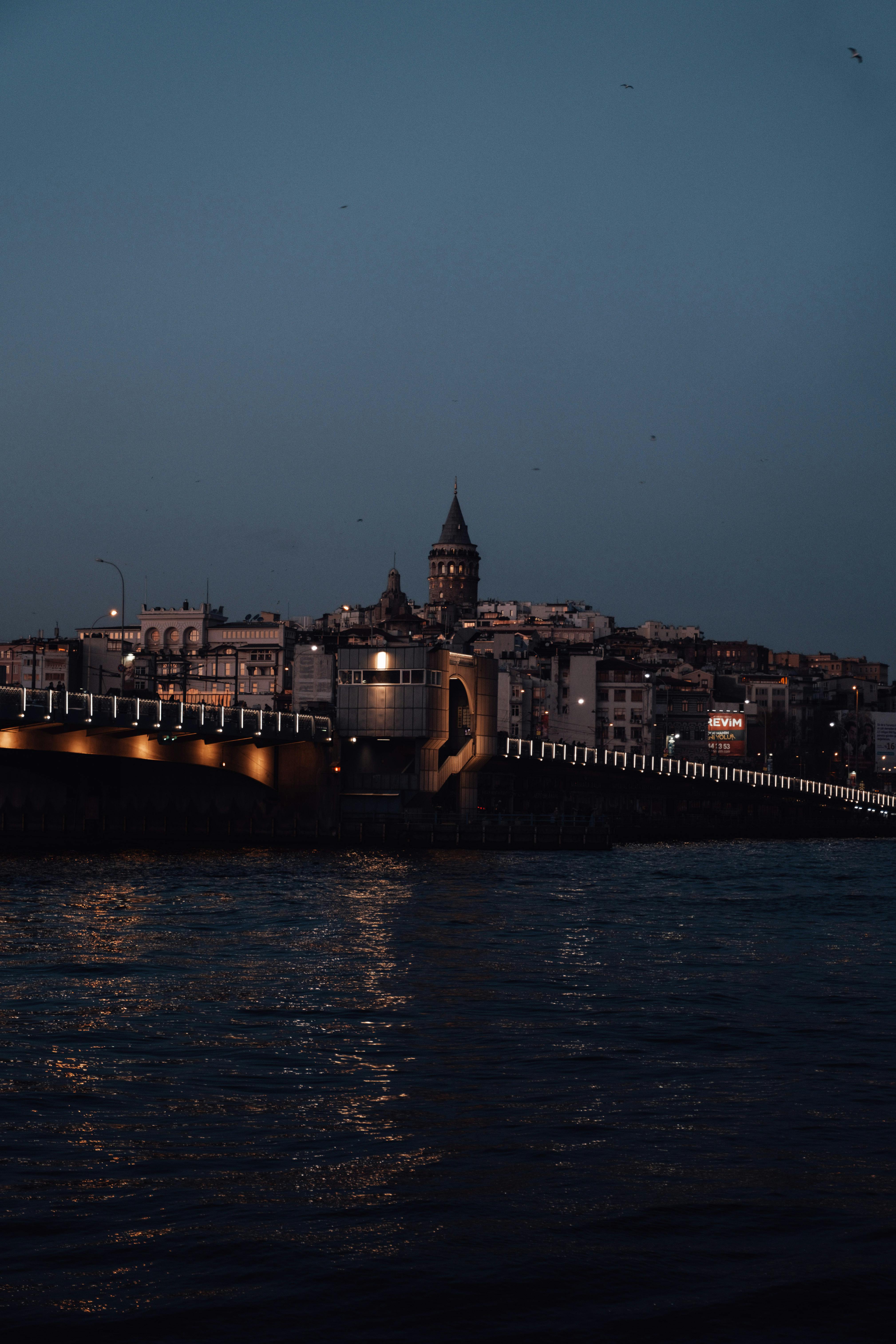 Illuminated bridge over river in city · Free Stock Photo