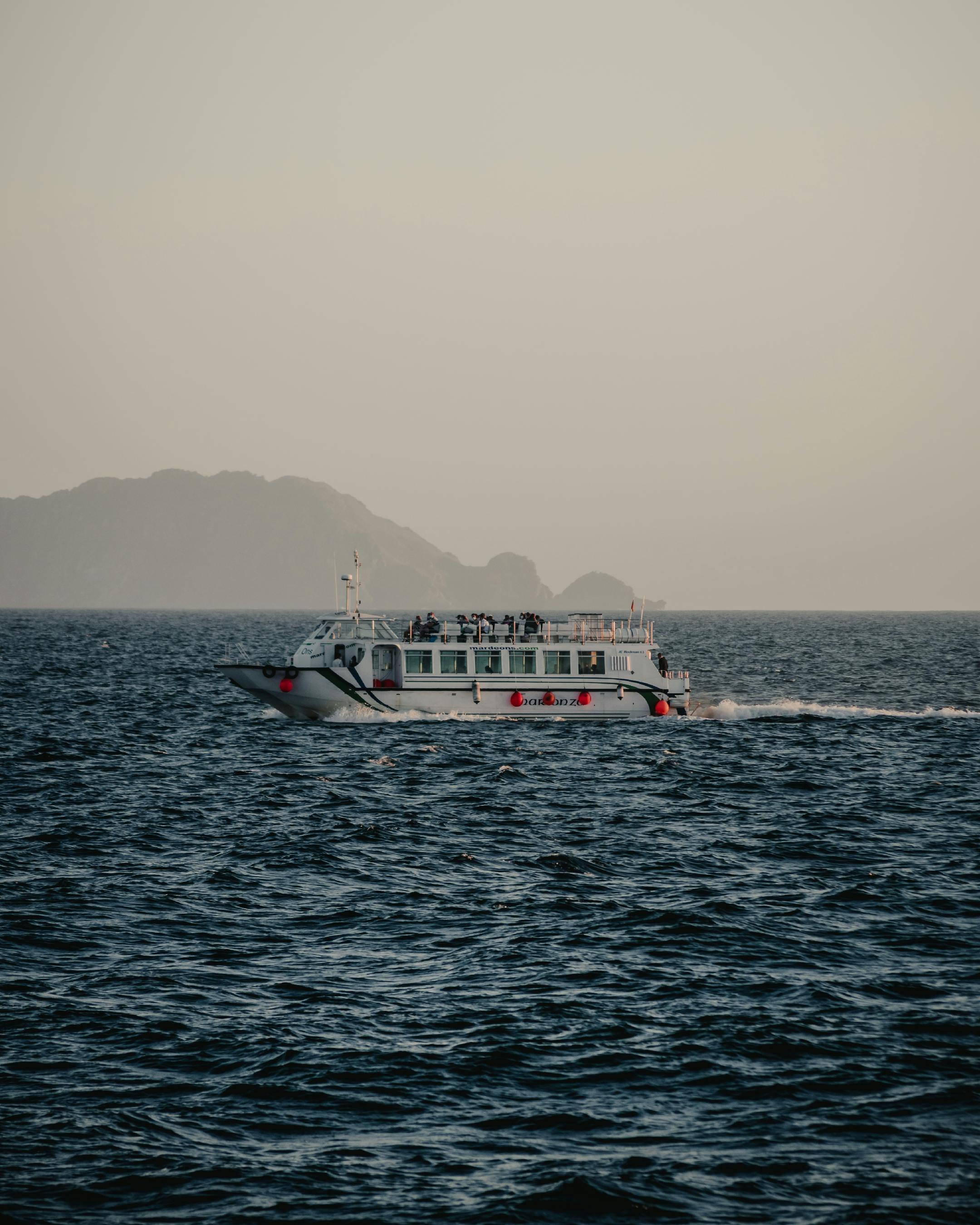 A Ferry Boat on the Water Under the Cloudy Sky · Free Stock Photo