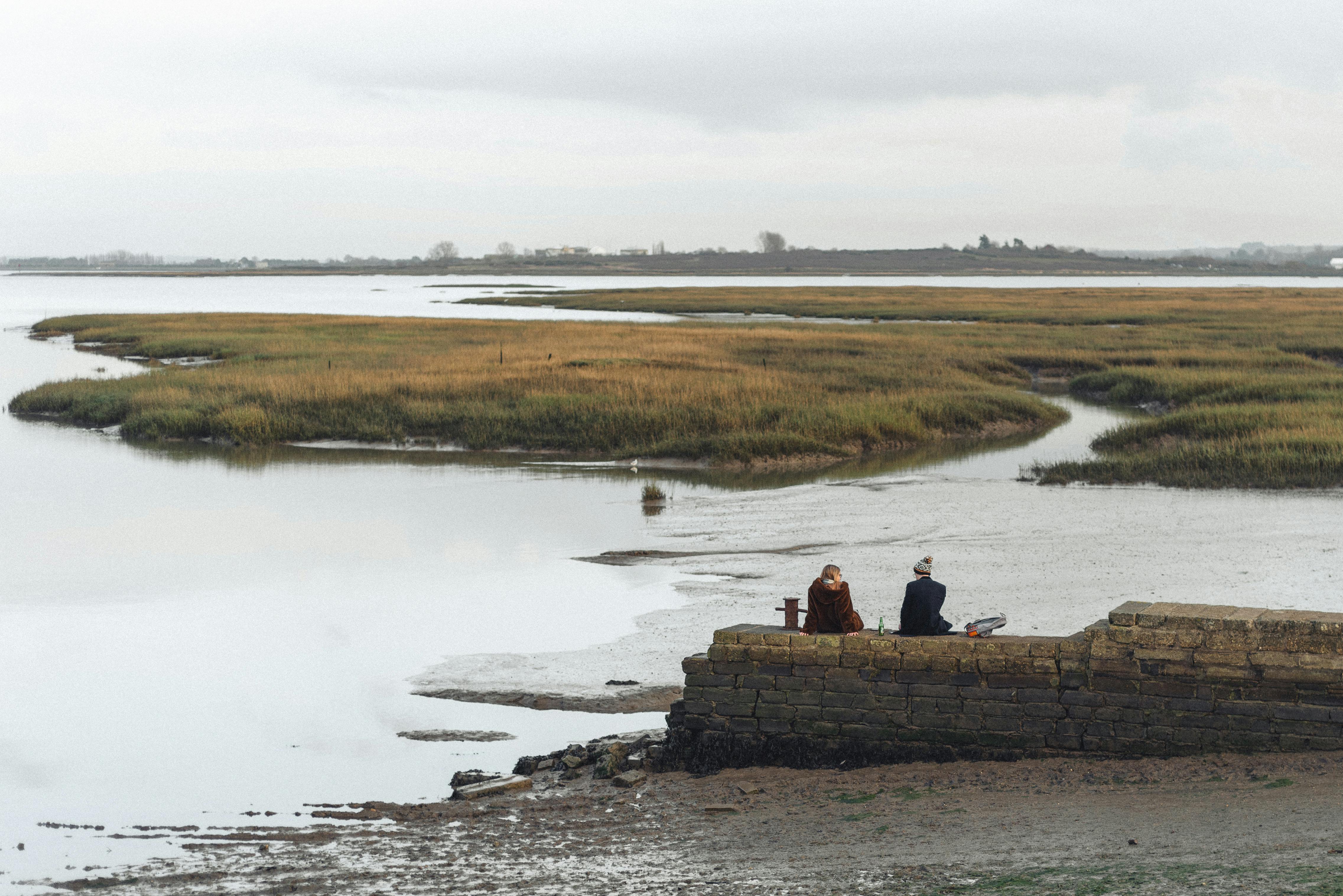 People Sitting by River in Autumn · Free Stock Photo