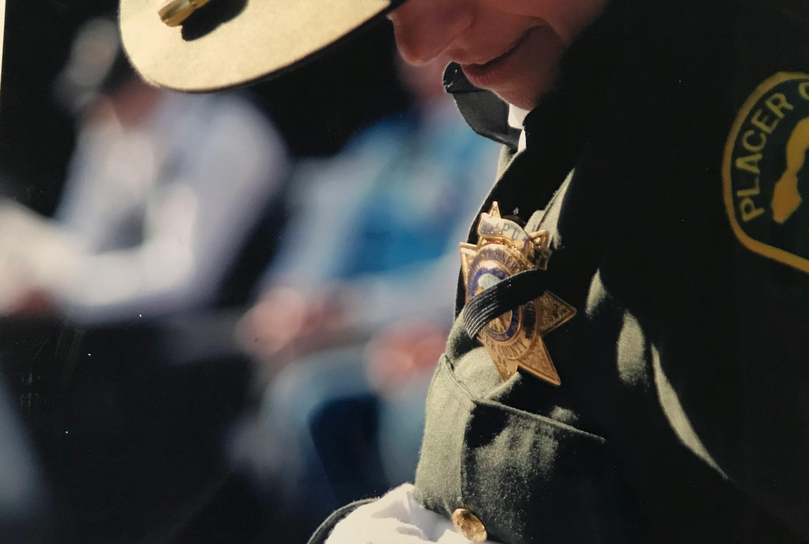 Policeman Looking at his Badge · Free Stock Photo