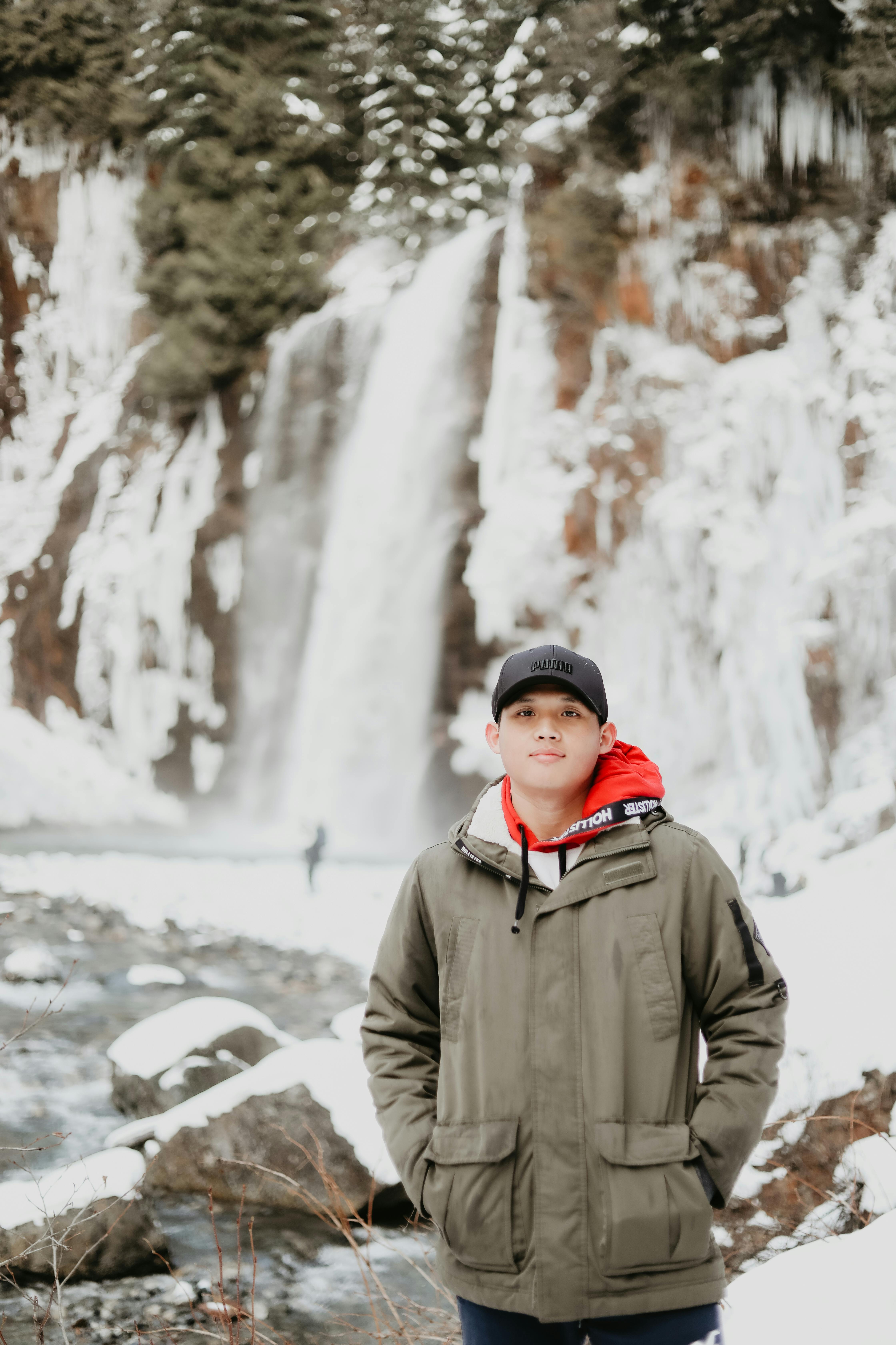 Man Standing Near Waterfalls · Free Stock Photo