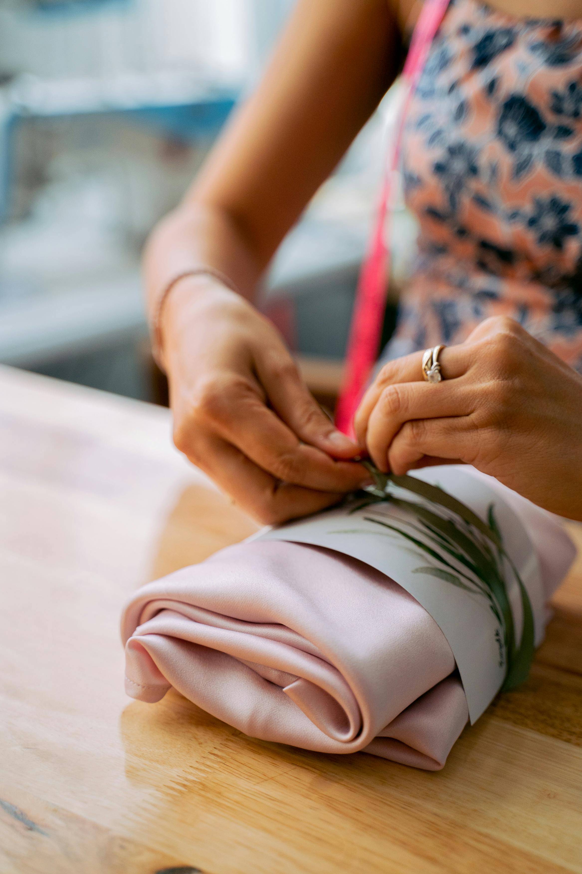 A Person's Hands Tying a Fabric · Free Stock Photo