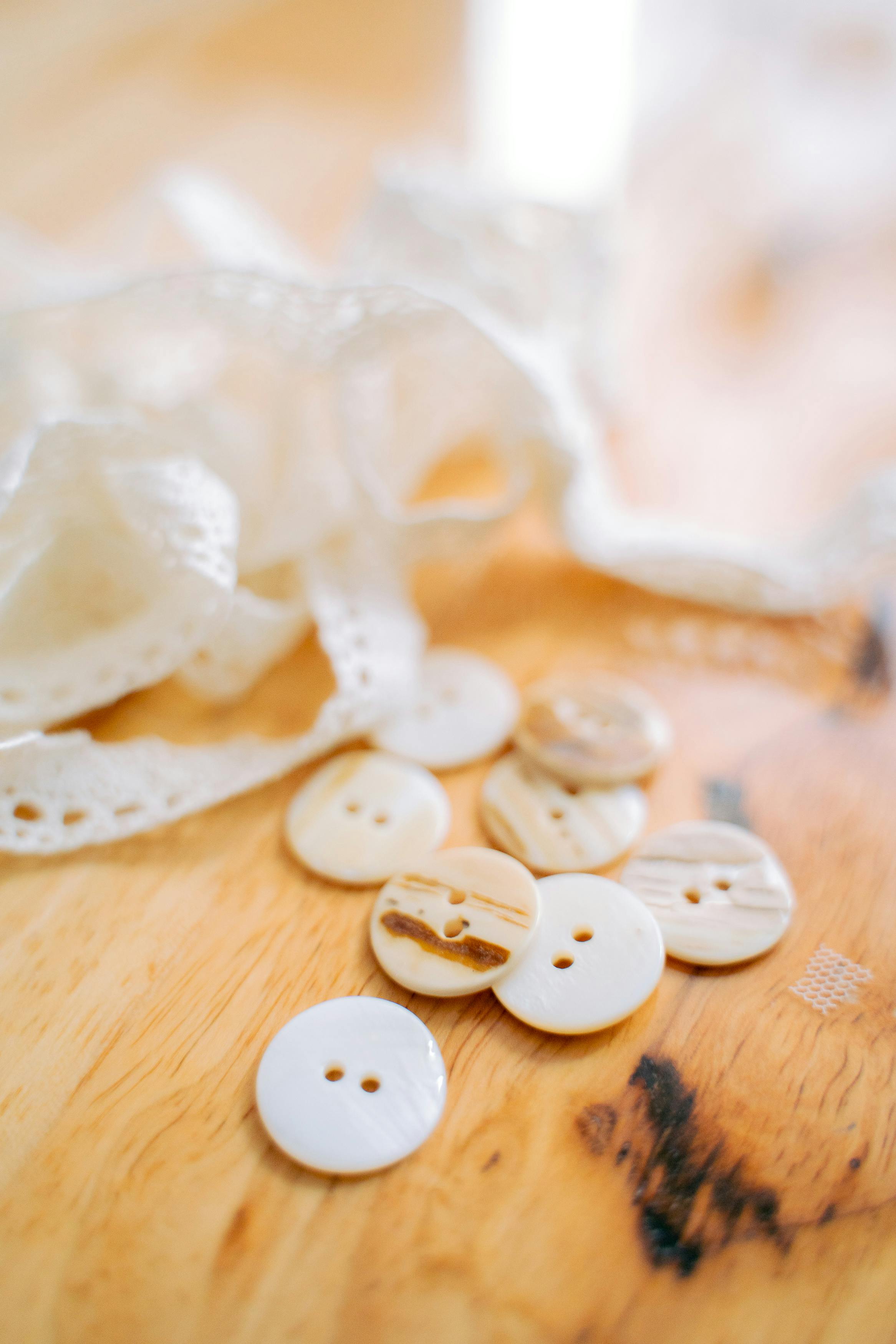 A White Lace Near Buttons · Free Stock Photo