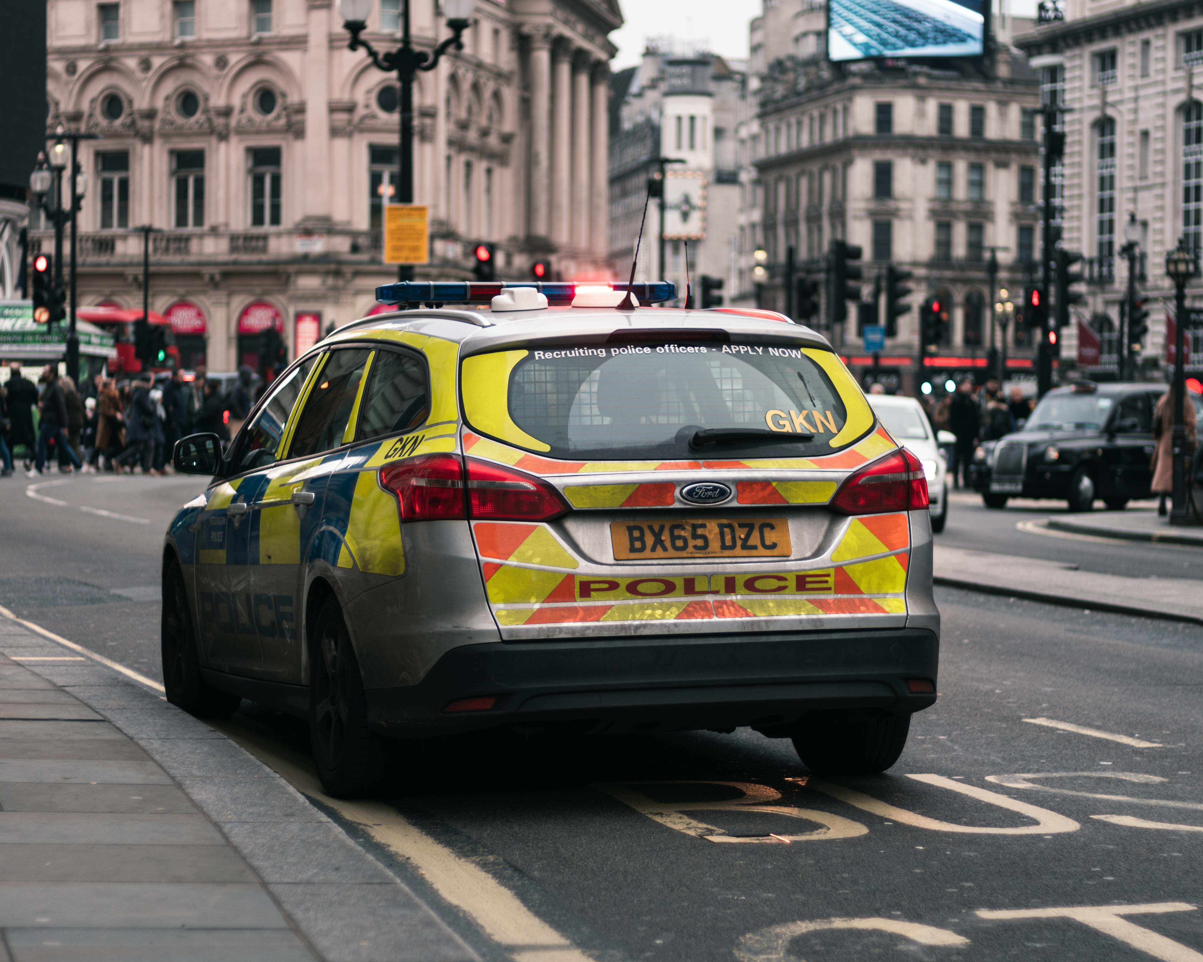 Police Car and a SUV parked on Roadside · Free Stock Photo