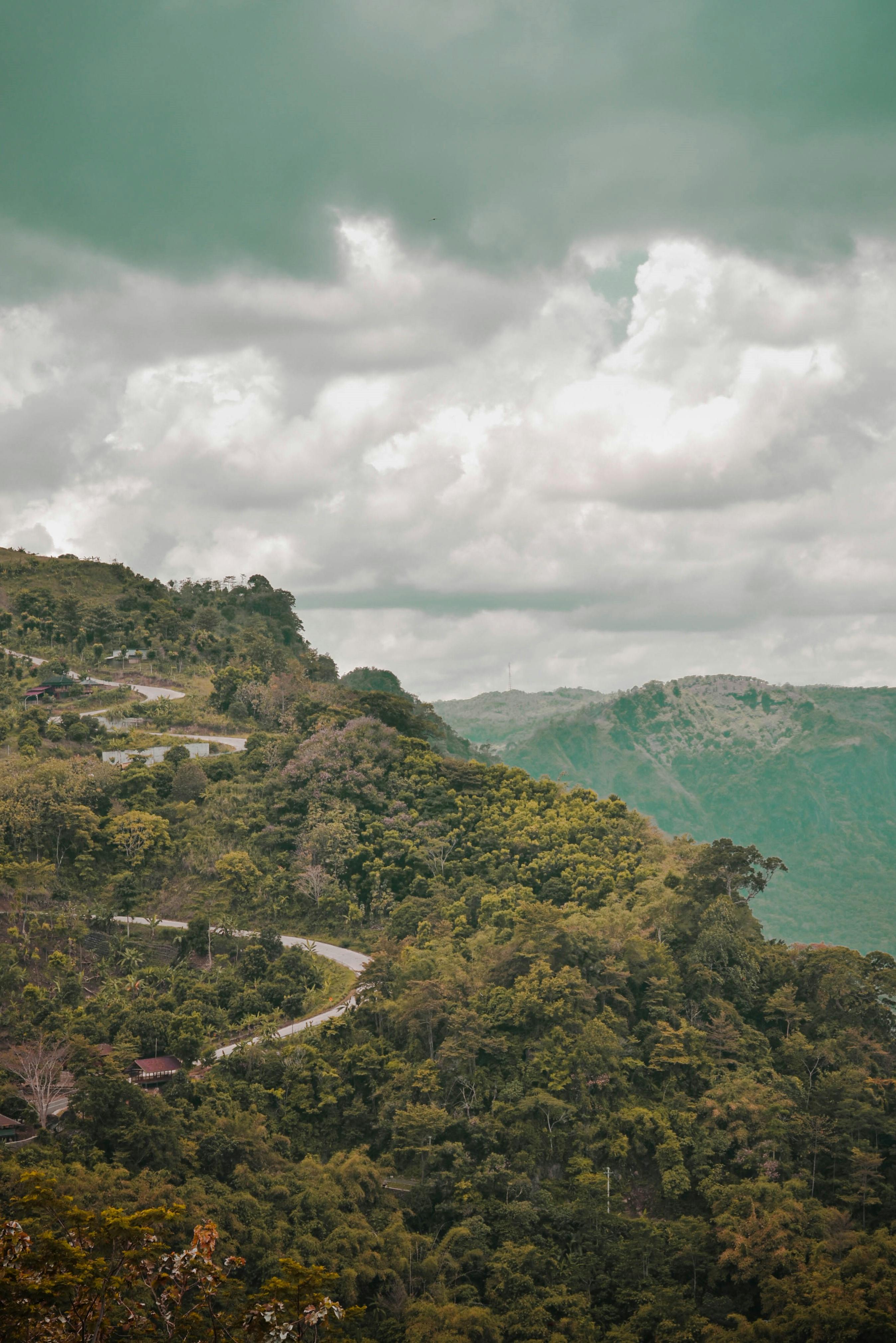 Winding Road along Stream in Mountains · Free Stock Photo