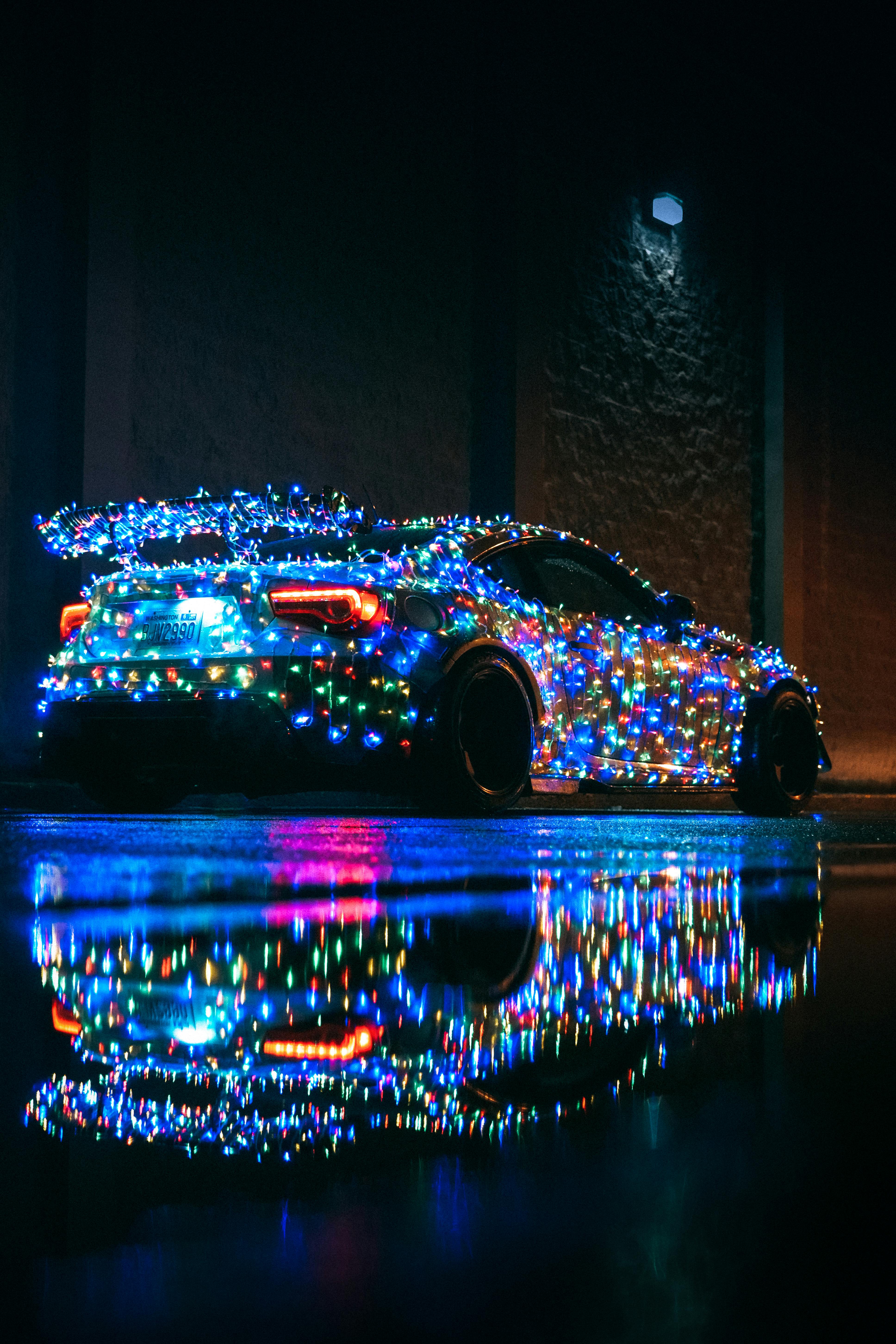 Colorful Lights Wrapped Around a Coupe Car · Free Stock Photo
