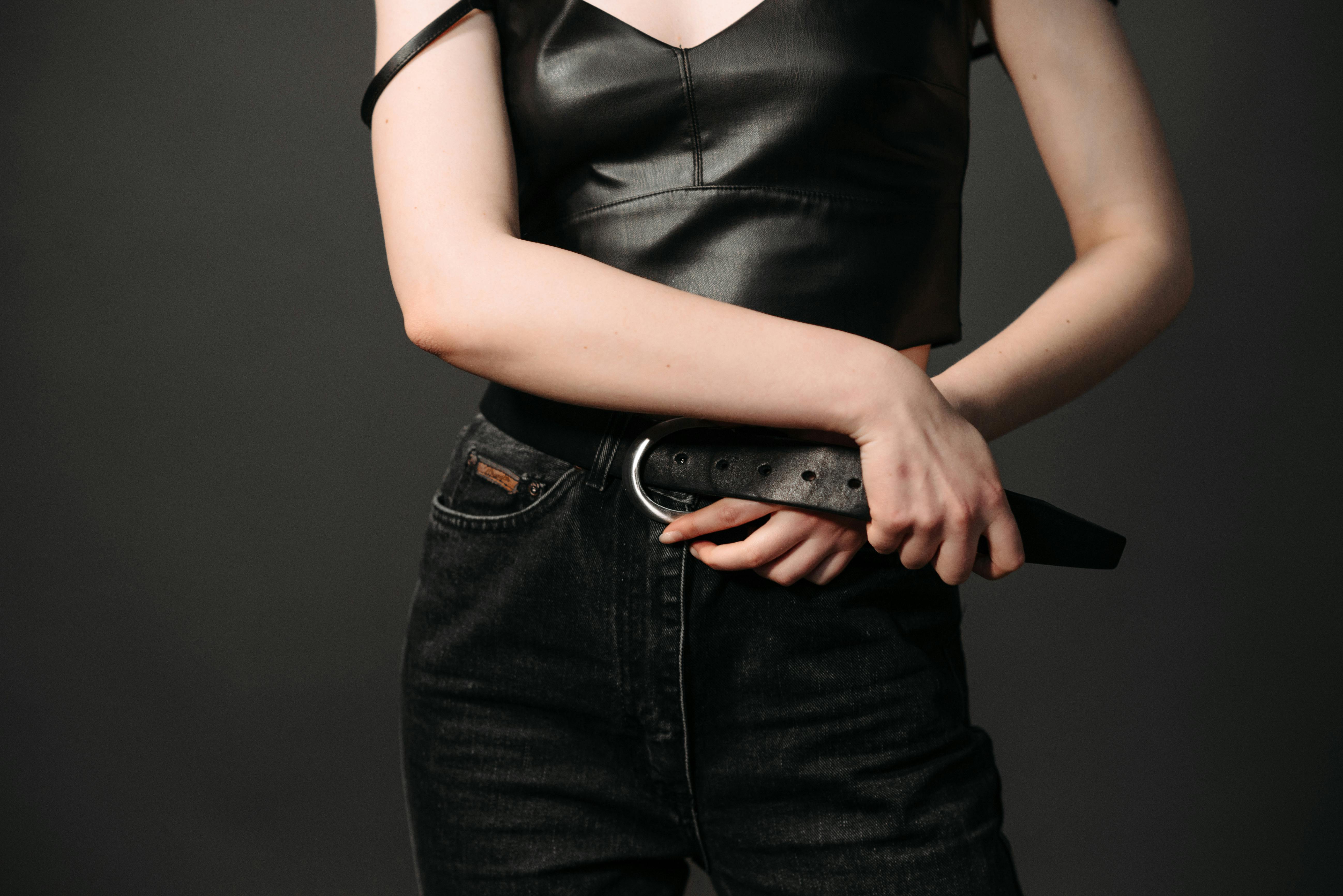 A Person Holding a Black Leather Belt · Free Stock Photo