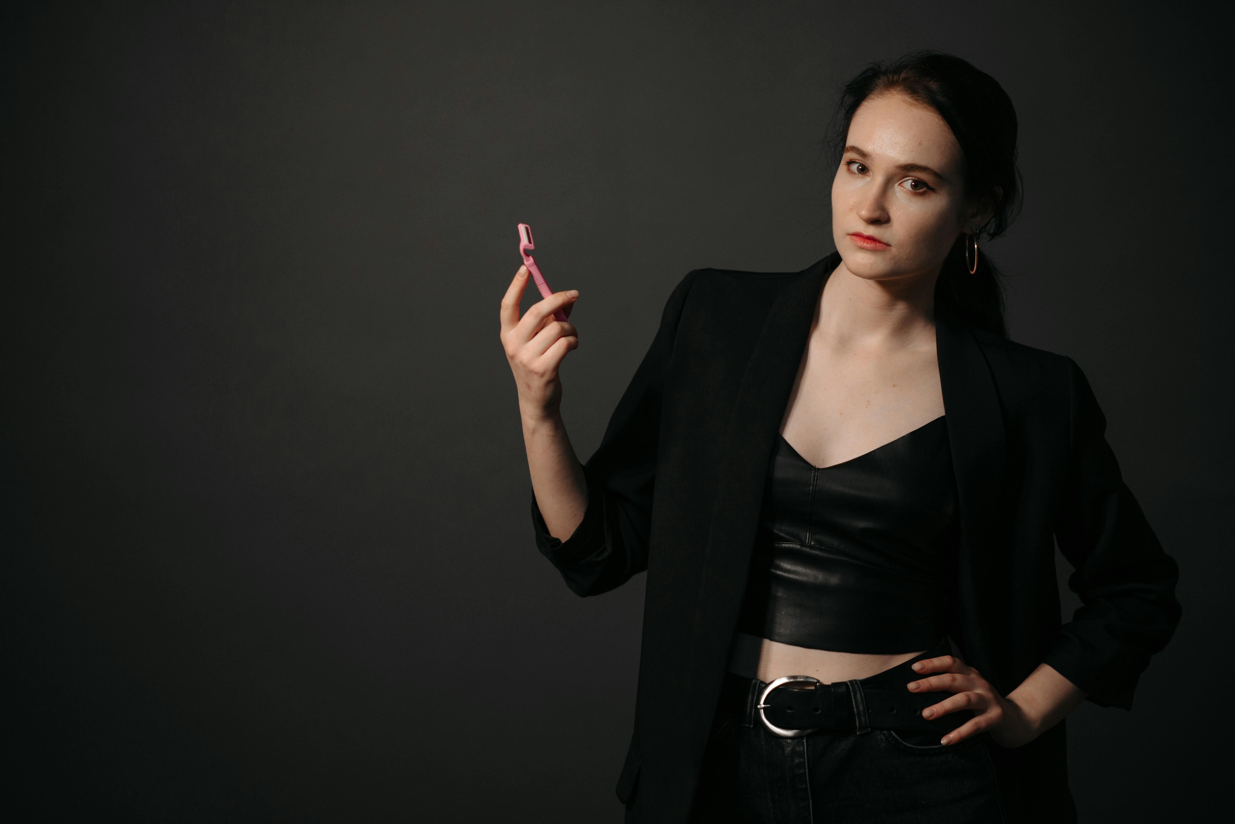 A Woman Holding a Razor · Free Stock Photo