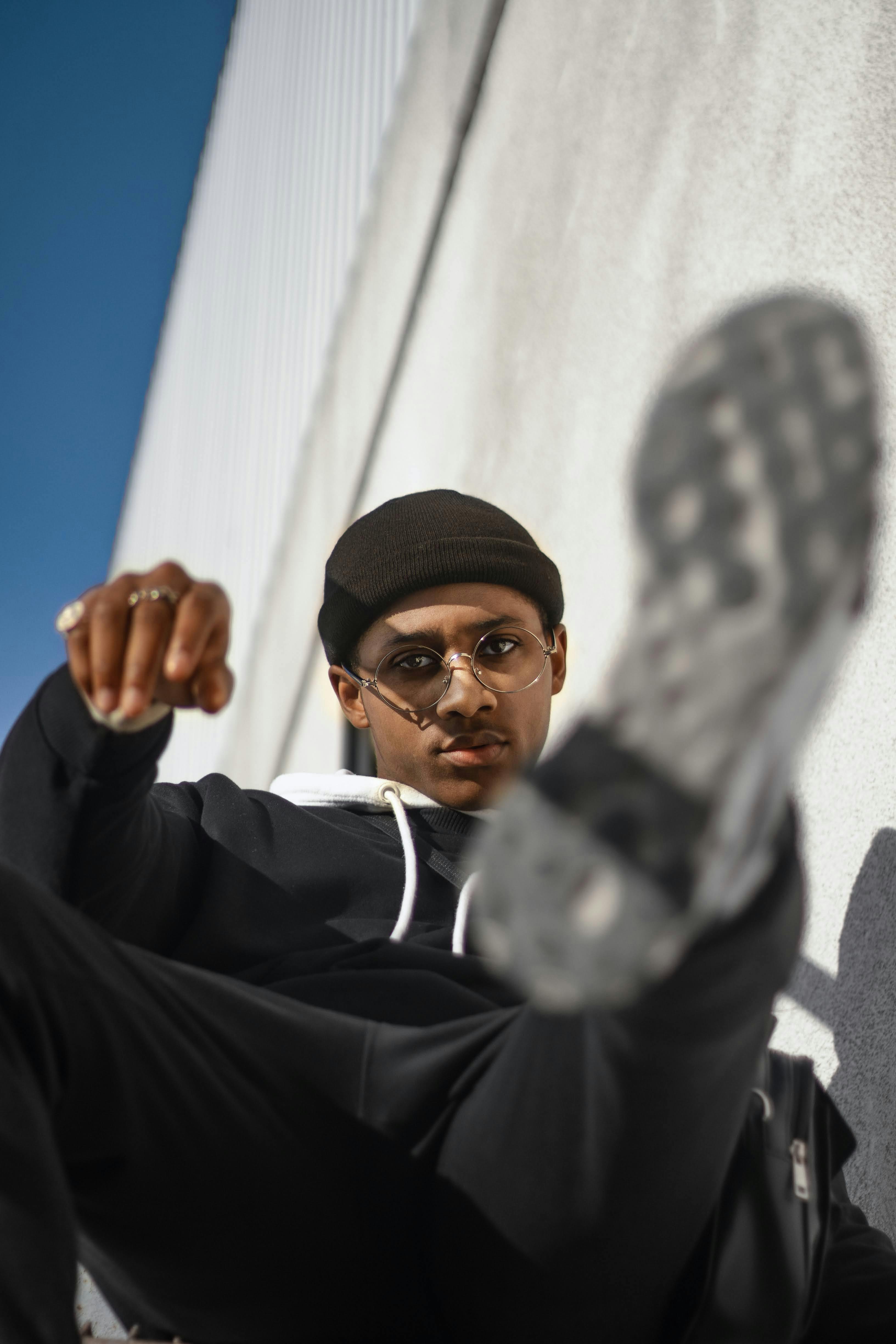 Low-Angle Shot of a Man Holding a Camera · Free Stock Photo