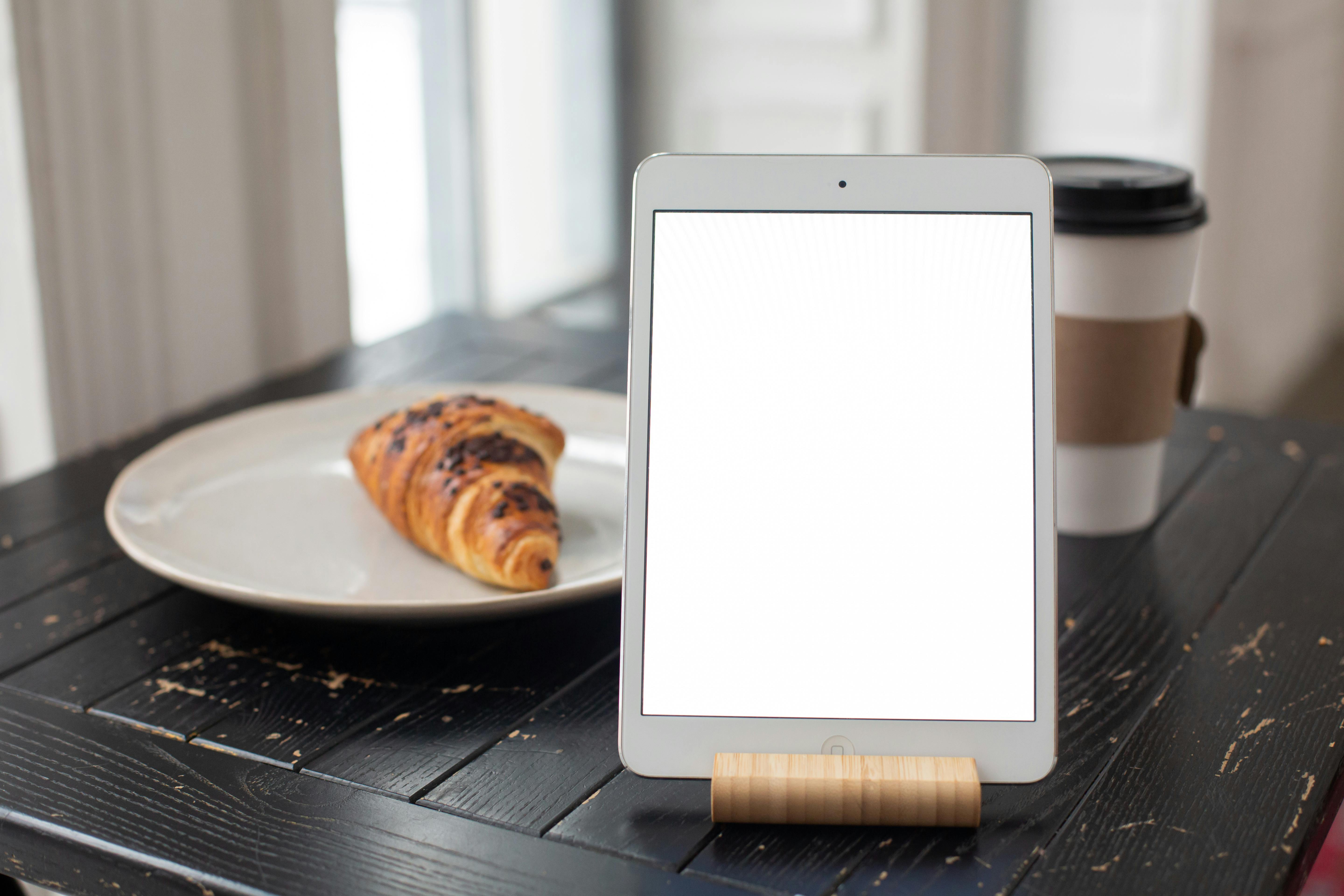 White Ipad and Items on White Surface · Free Stock Photo