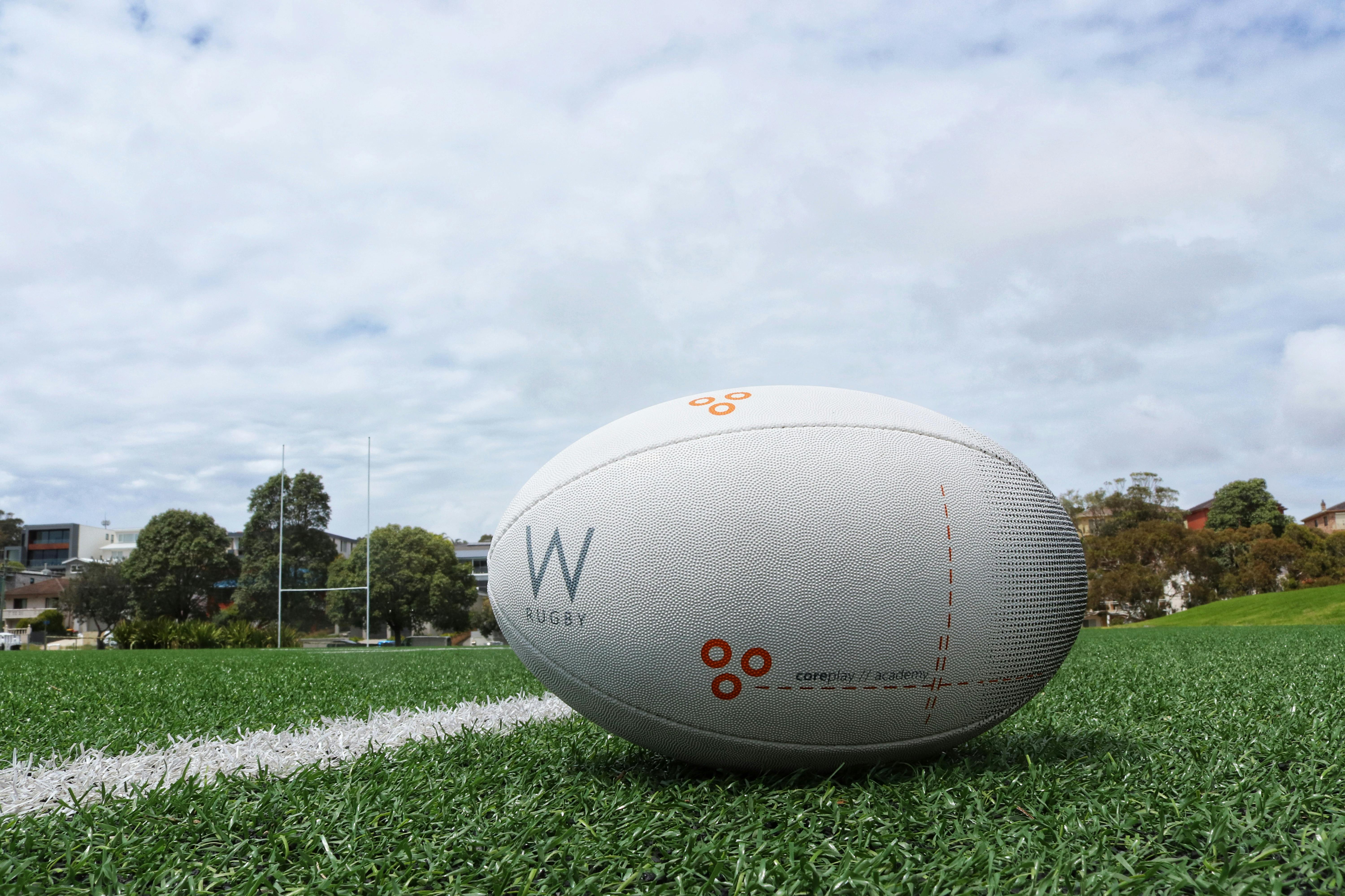 White Rugby Ball on the Grass · Free Stock Photo