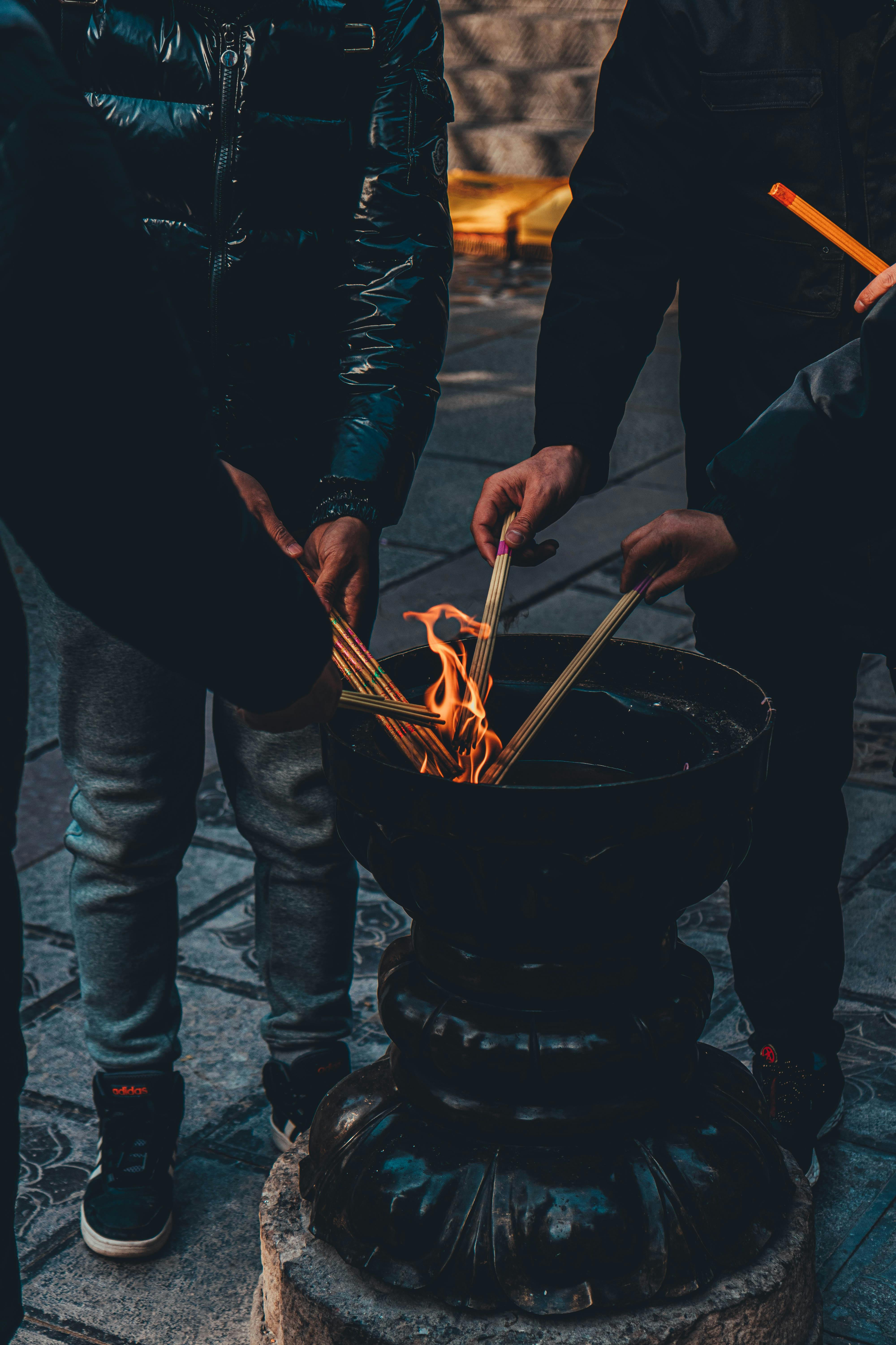 People Burning Sticks · Free Stock Photo