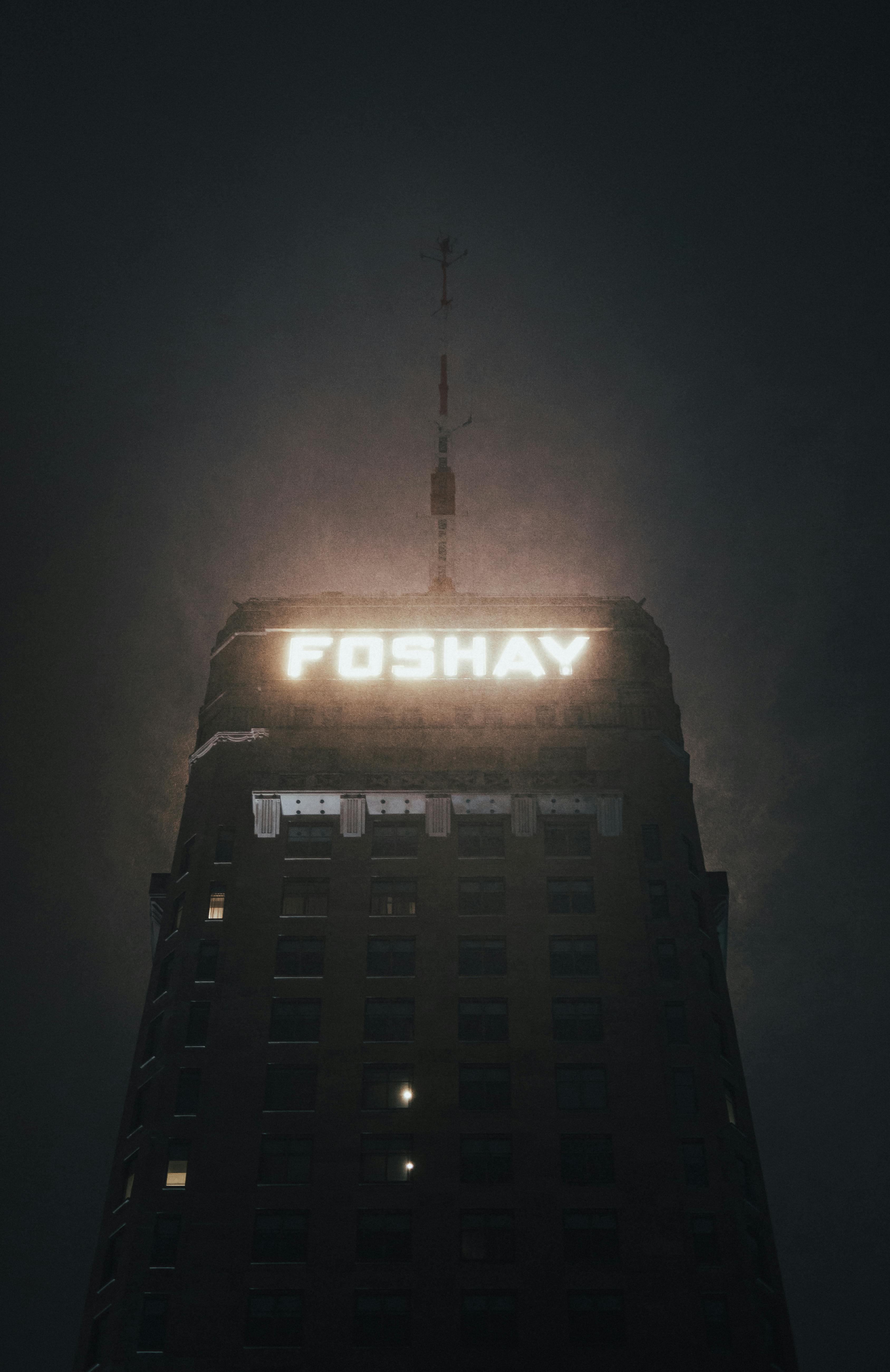 Person Standing at the edge of Building at Night · Free Stock Photo