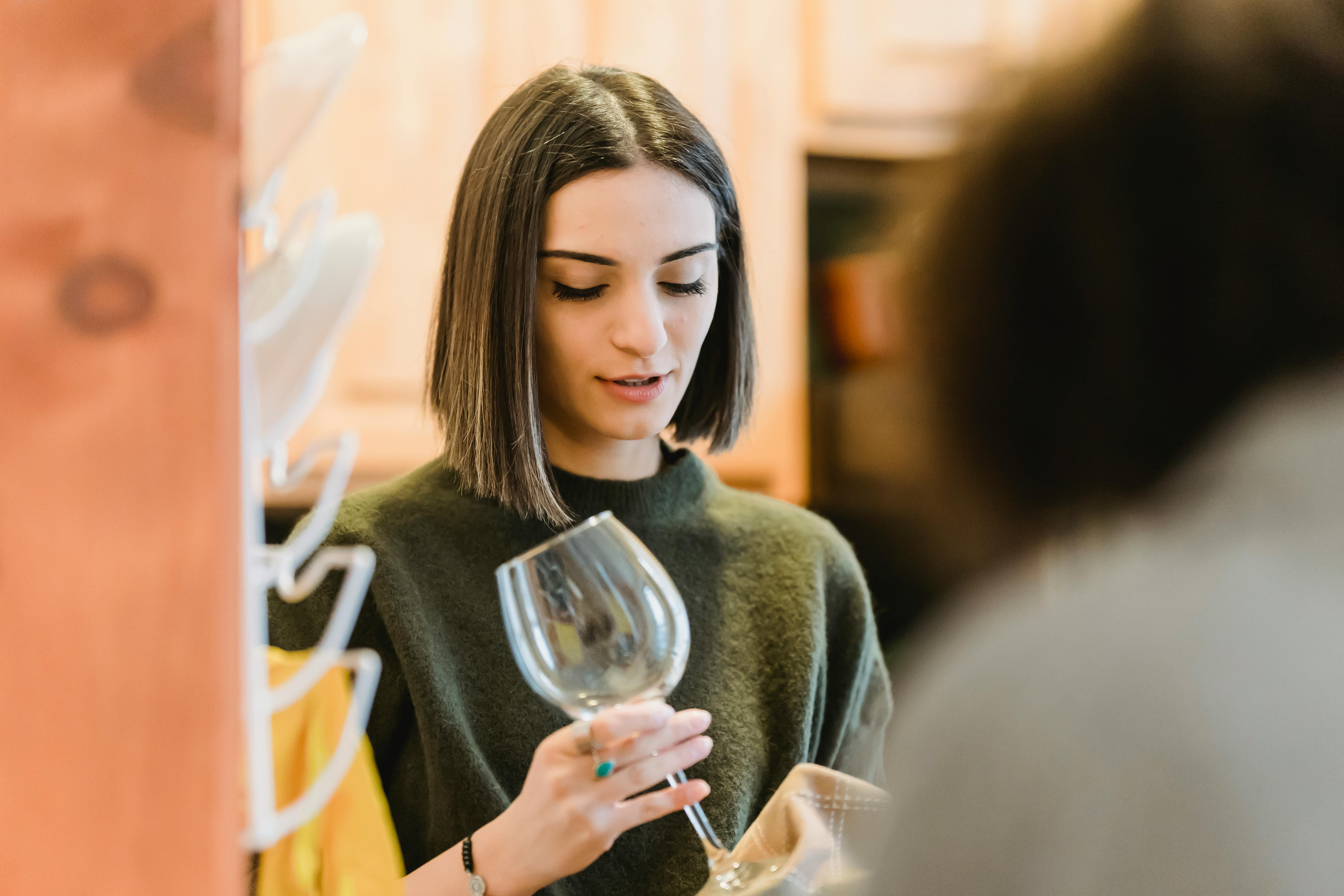 Young content woman talking with friend while drying glass · Free Stock ...