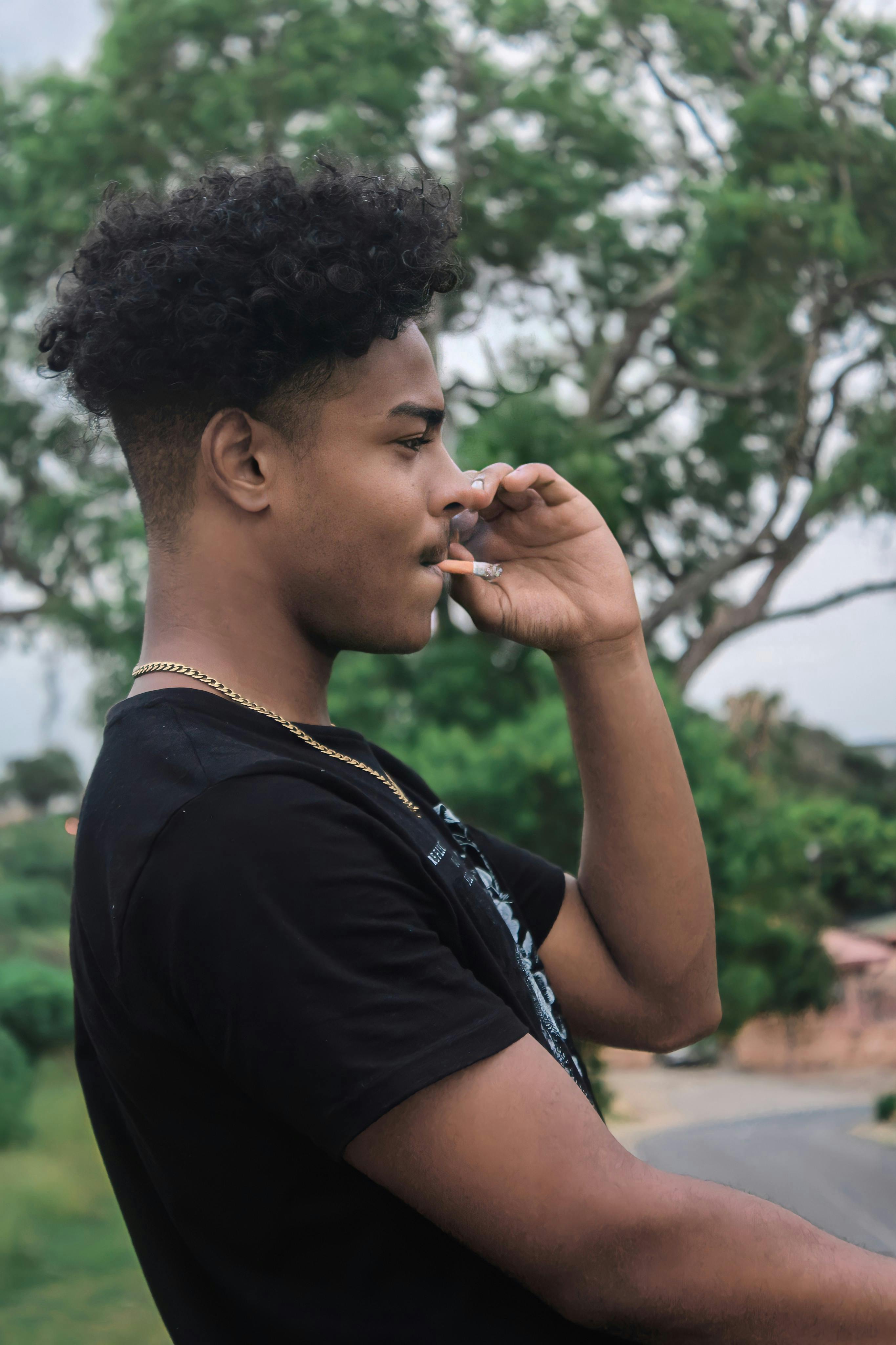 Woman in Black Top Smoking a Cigarette · Free Stock Photo