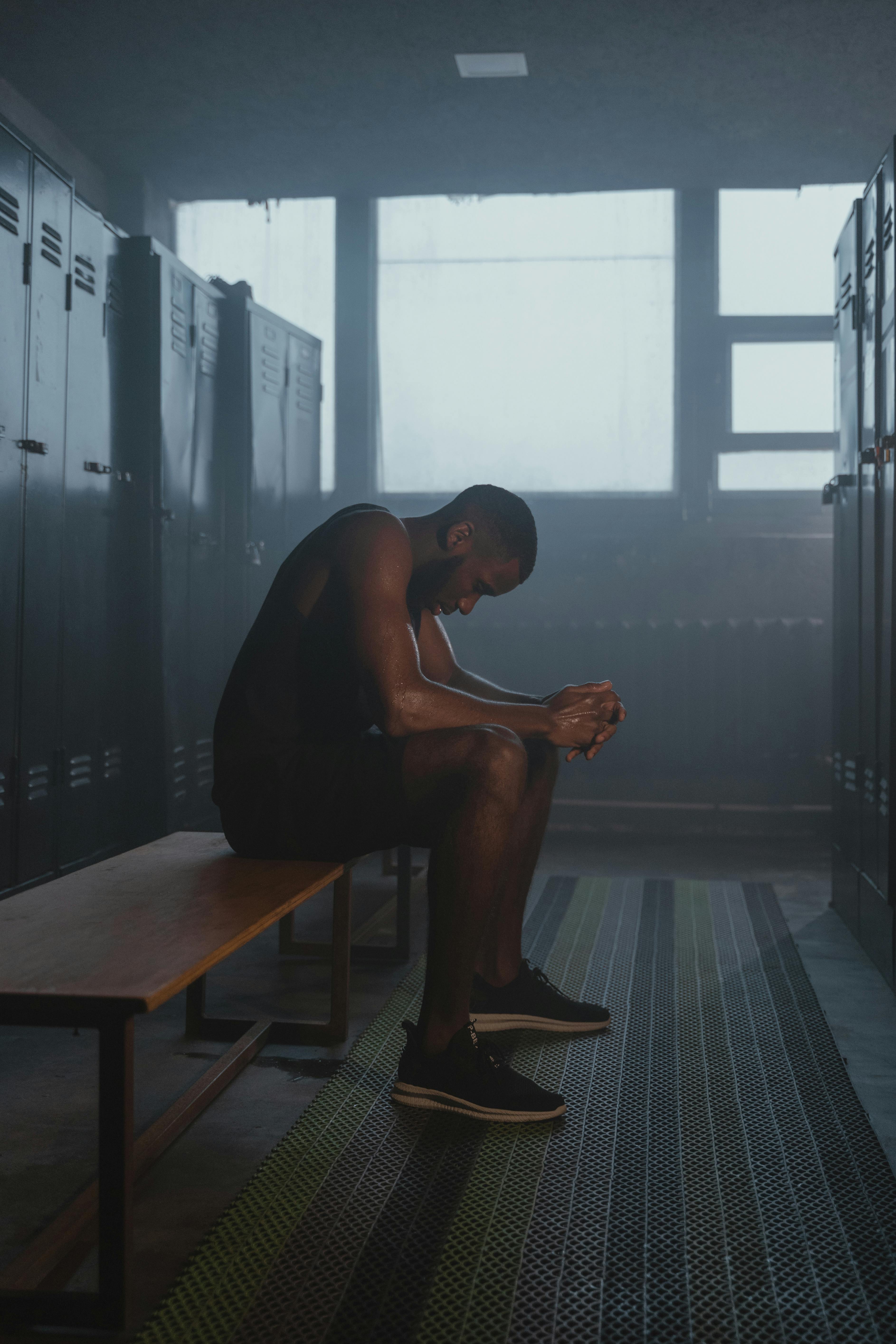 Man in Black Shorts Sitting on a Wooden Bench in a Locker Room · Free ...