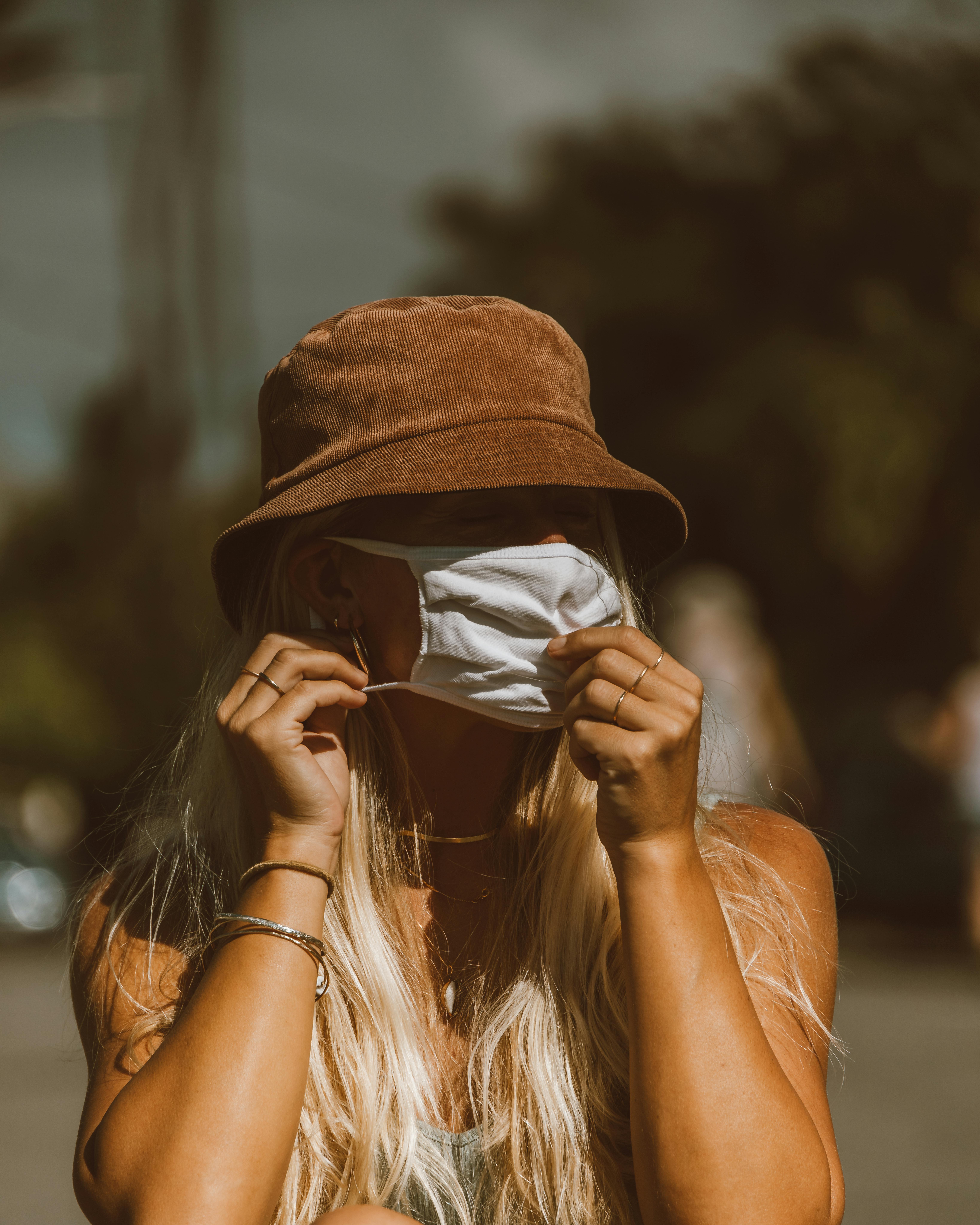 A Woman Wearing a Hat and a Face Mask · Free Stock Photo