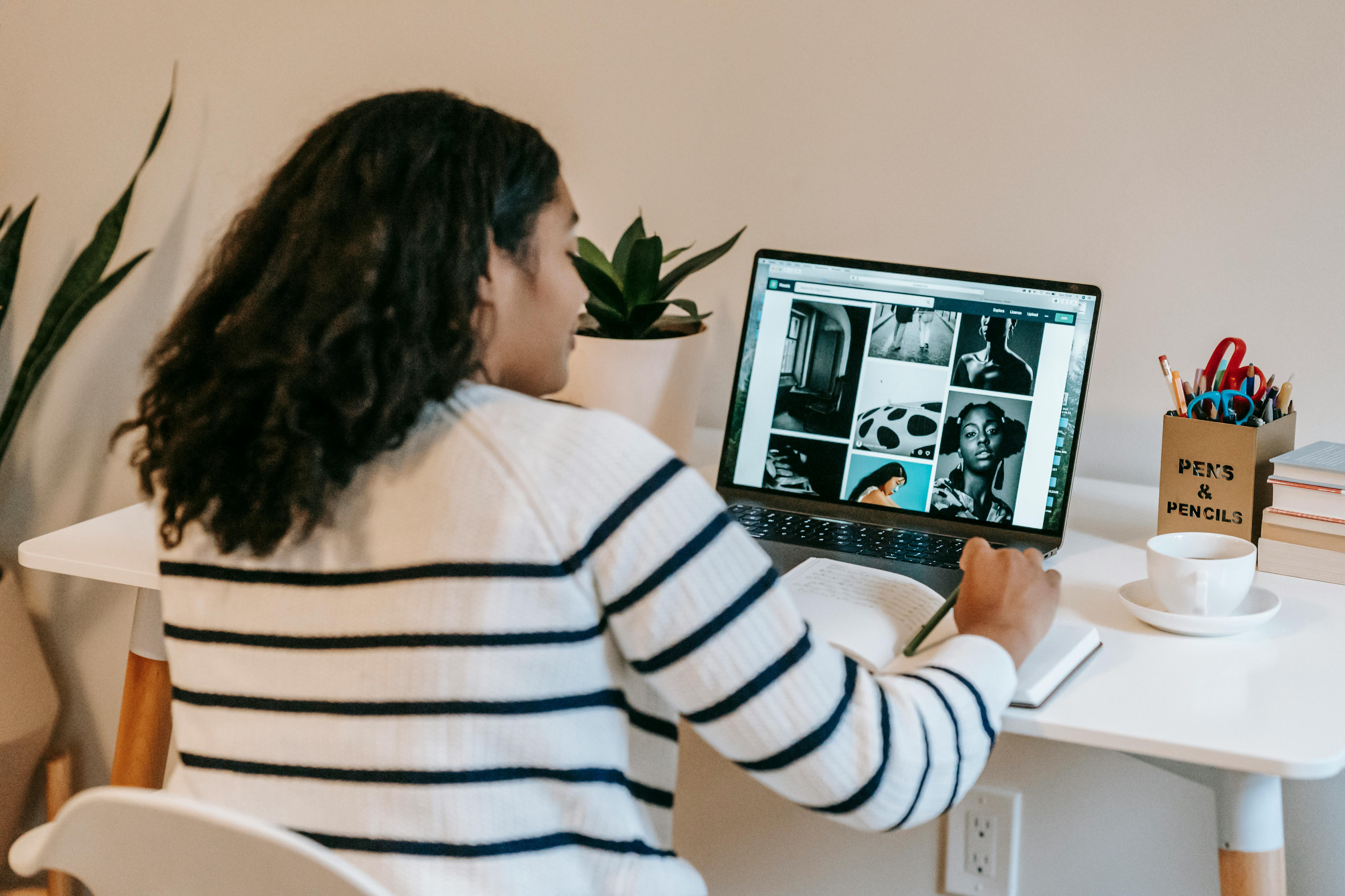 Faceless ethnic lady working remotely on laptop with notepad · Free ...
