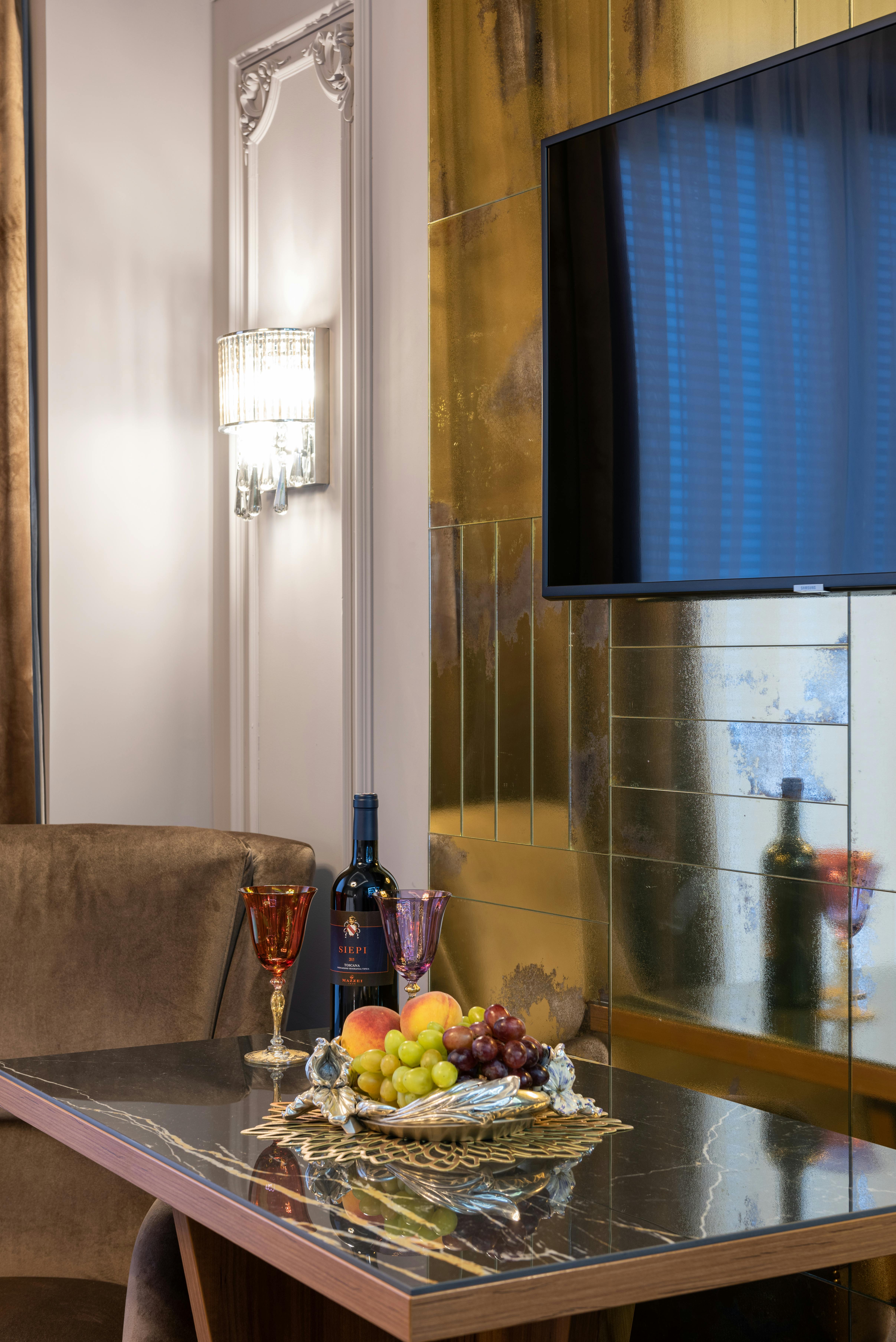 Modern TV set under table with fruits and wine indoors · Free Stock Photo