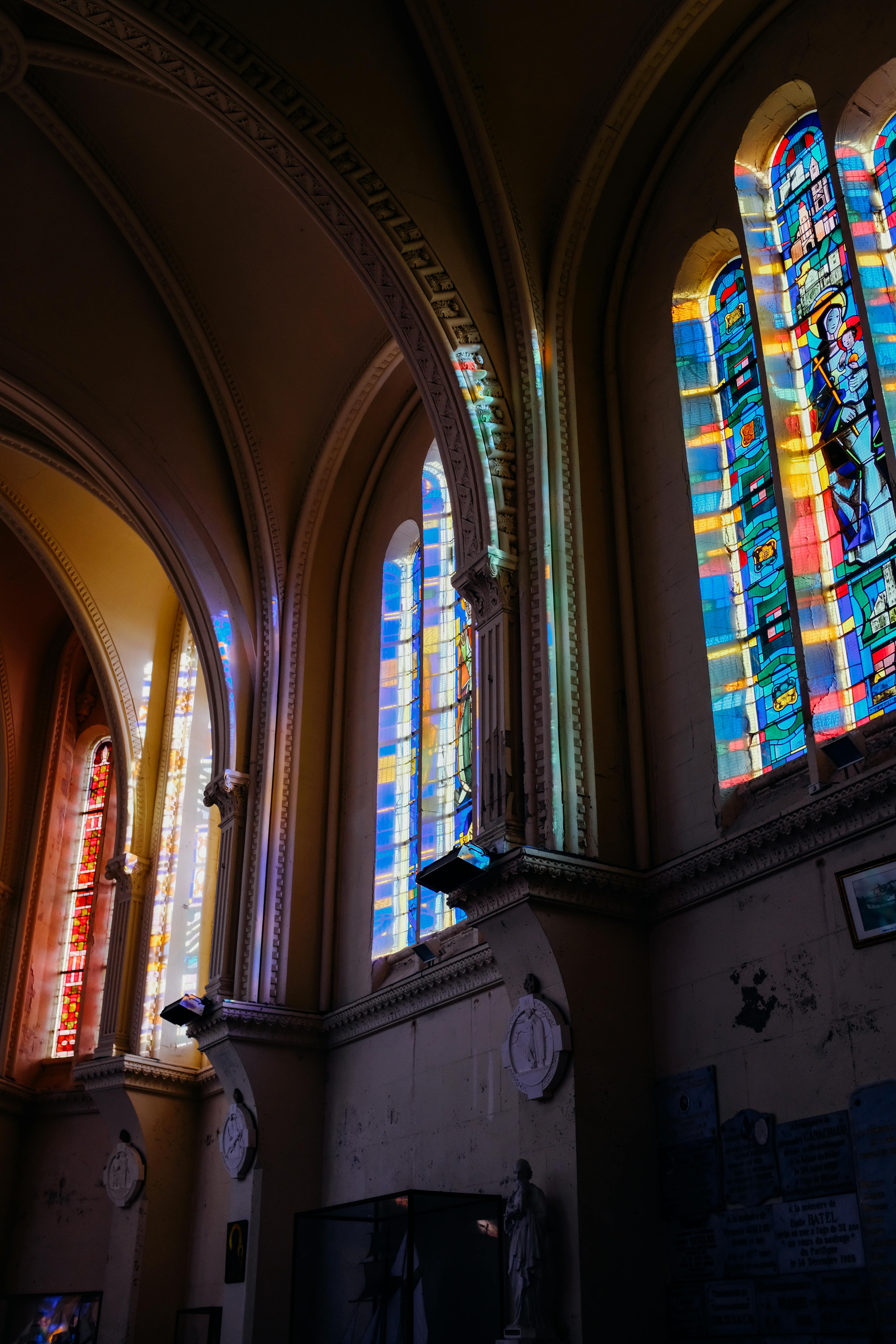 Interior of medieval cathedral with colorful leaded glass windows ...