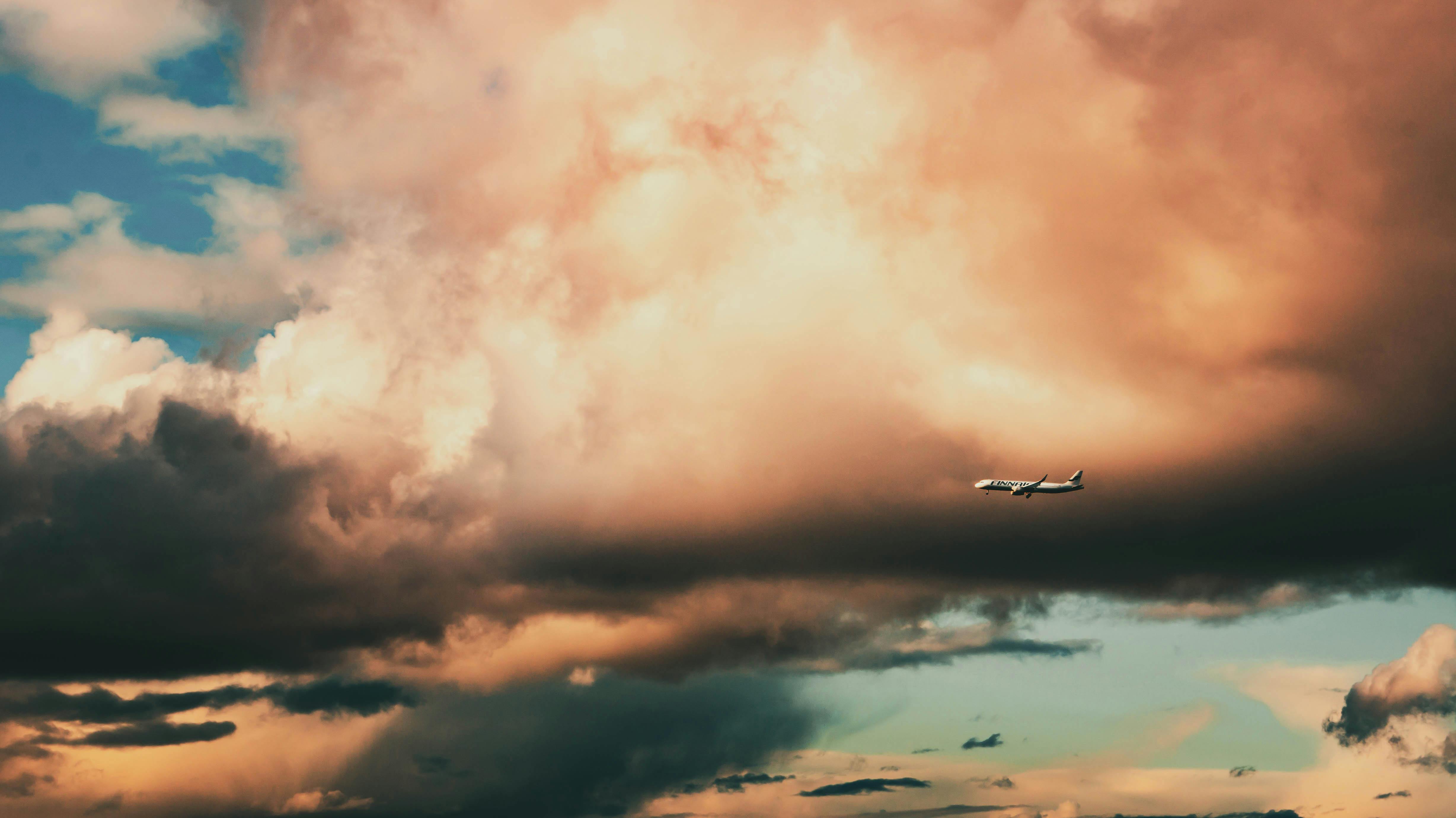 Airplane Flying by Tower Wall · Free Stock Photo