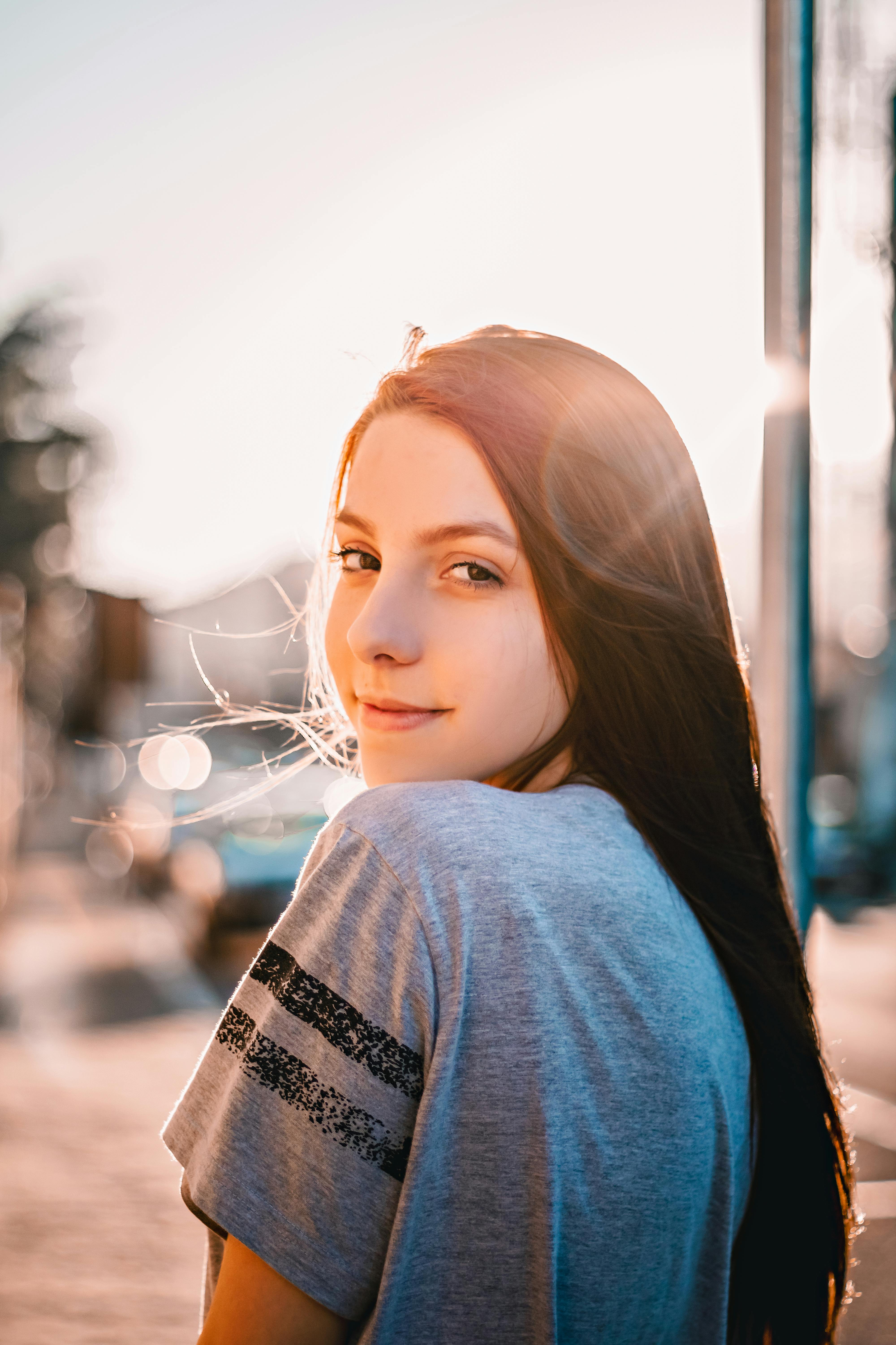 Dreamy young lady chilling on city street at sunset · Free Stock Photo