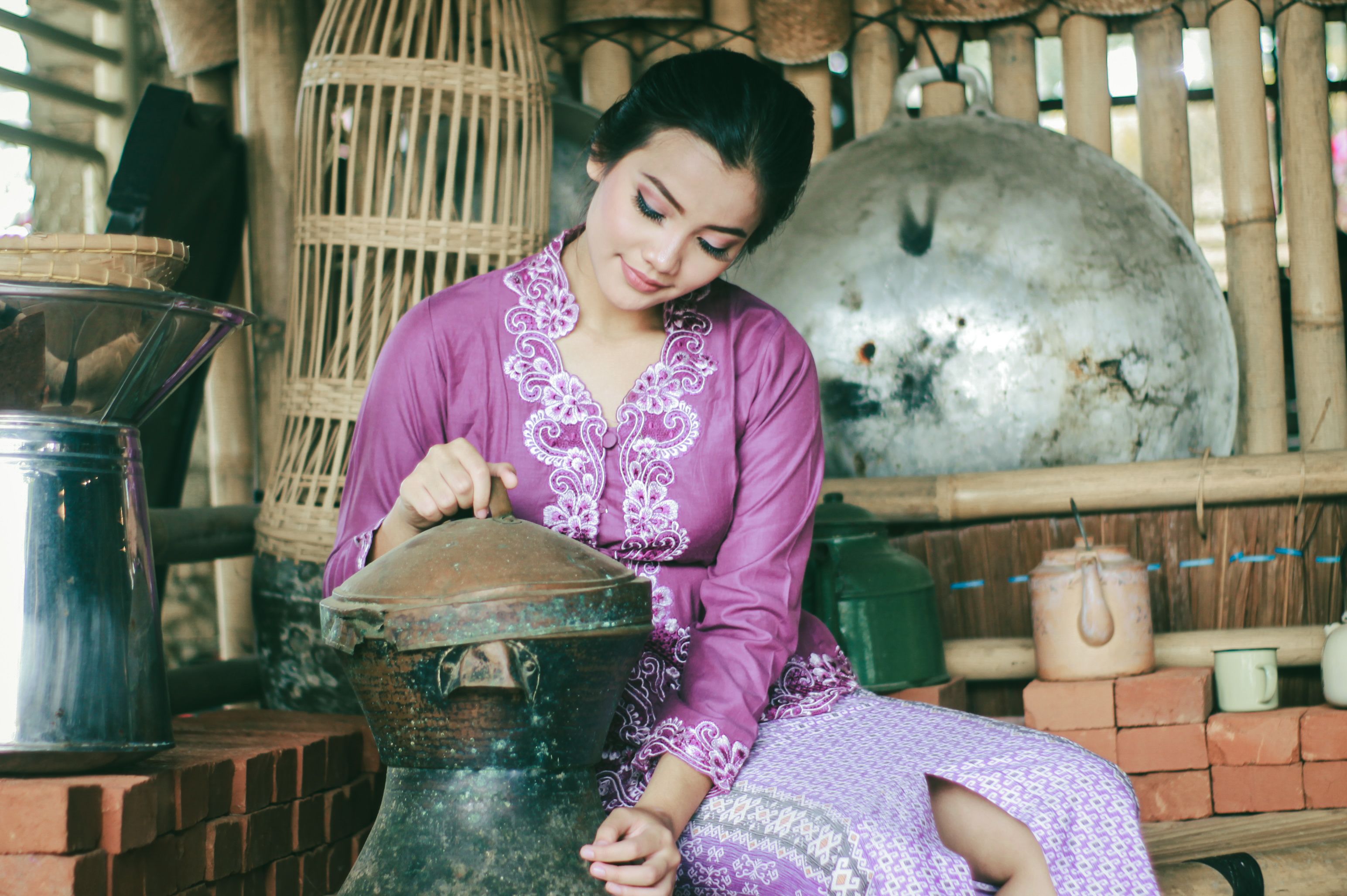 A Woman in Traditional Dress Holding Cooking Pot · Free Stock Photo