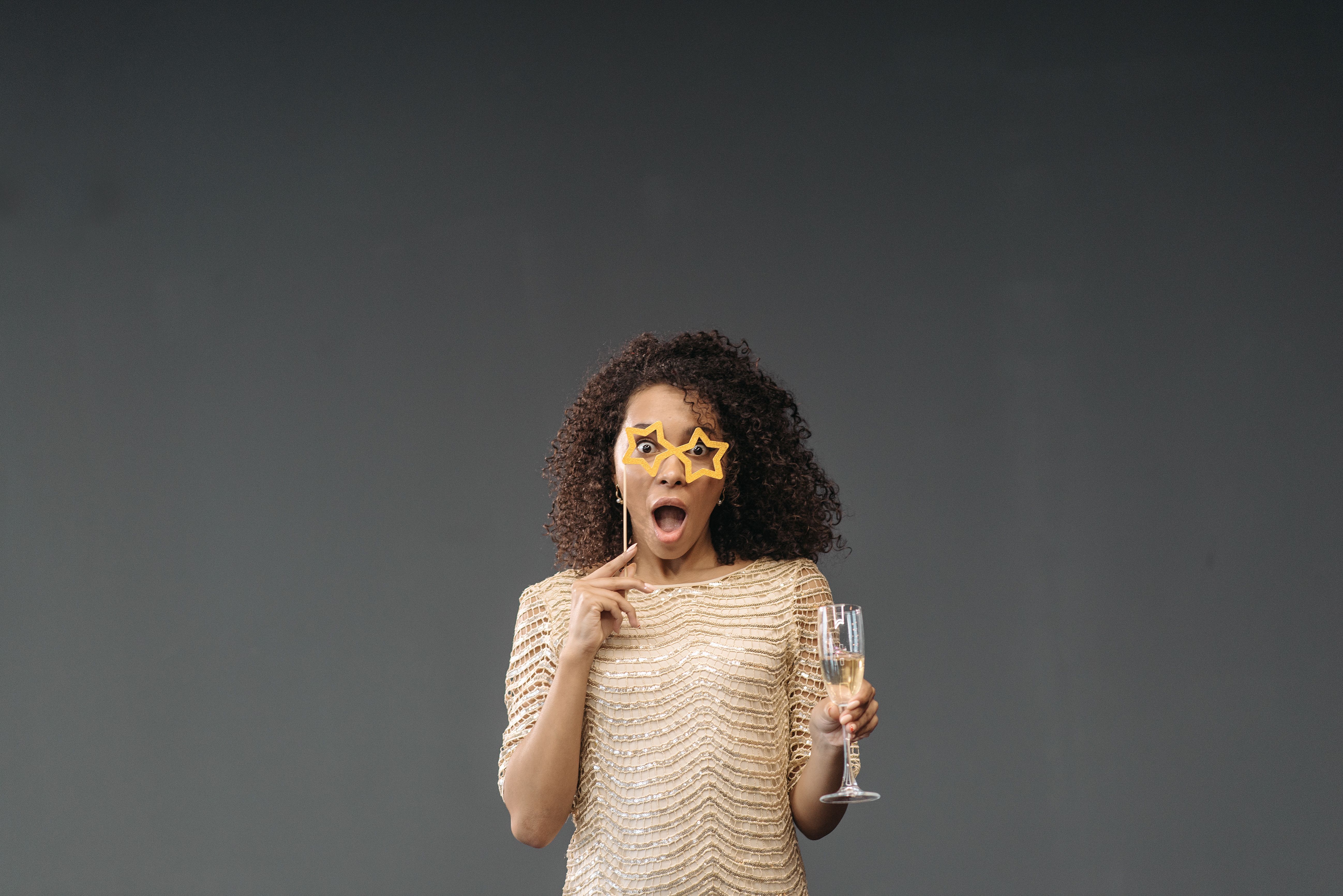 Surprised Woman holding Glass of Champagne · Free Stock Photo