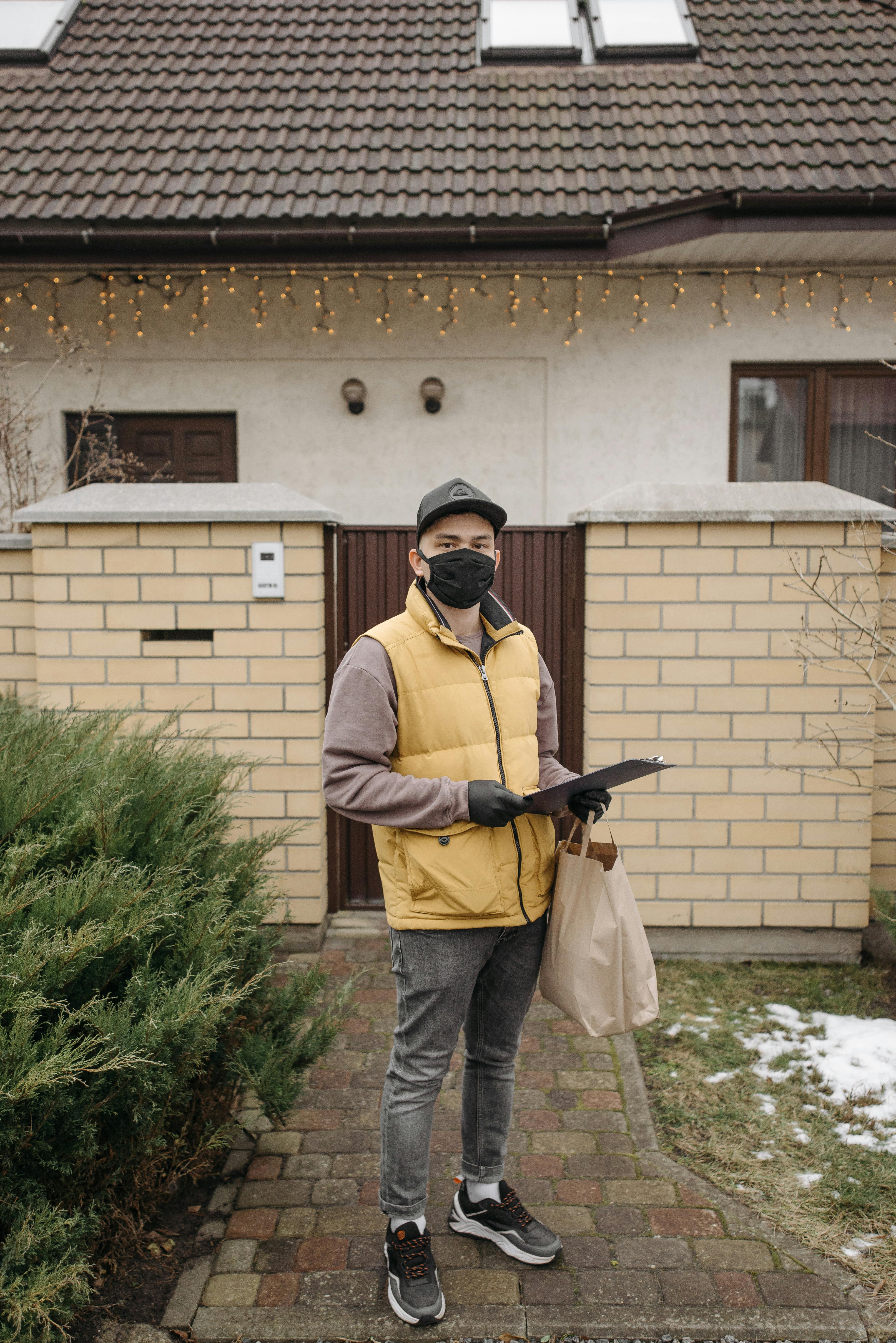 Man Standing Beside a Gate Entrance · Free Stock Photo