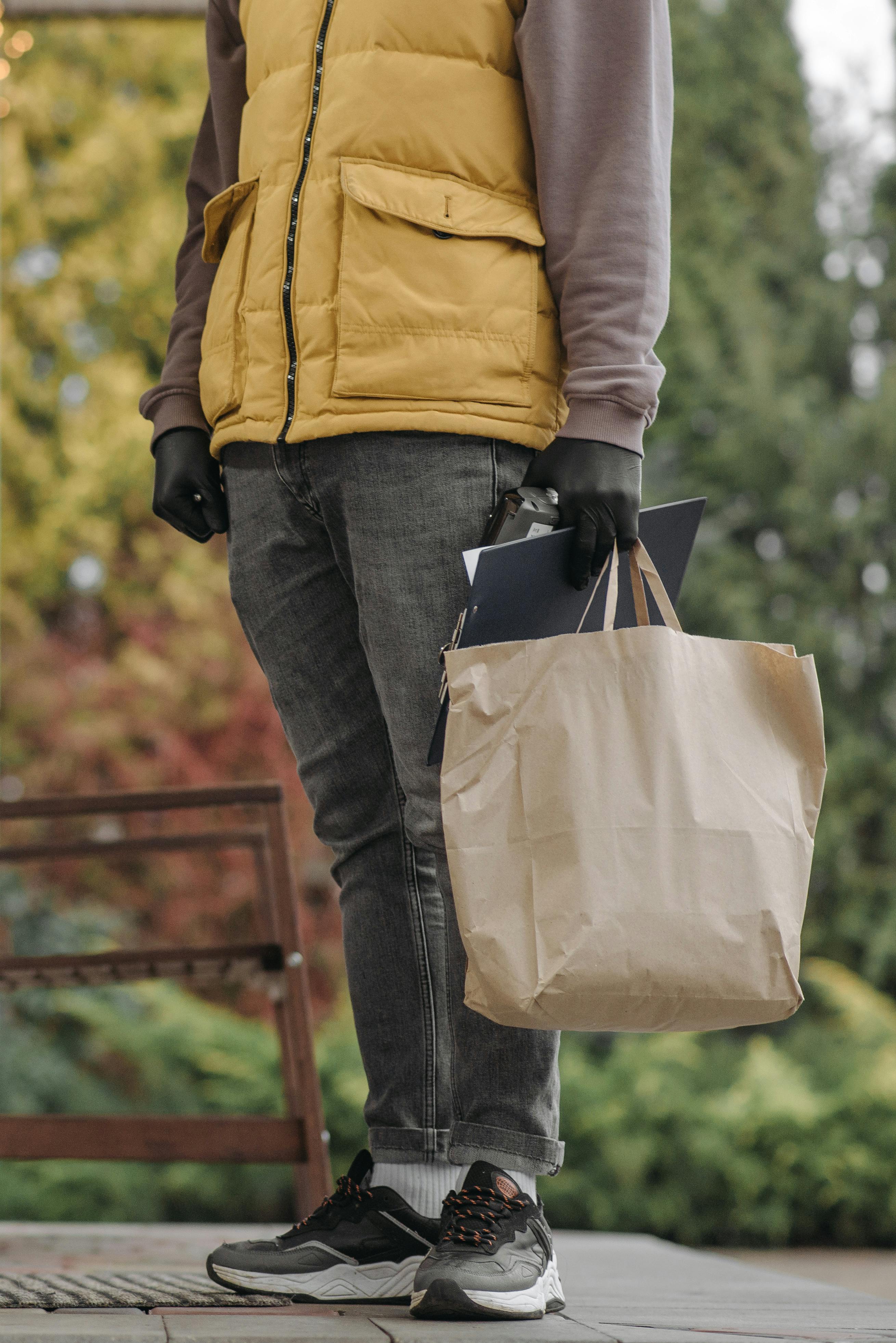 Person Holding Brown and White Paper Bags · Free Stock Photo