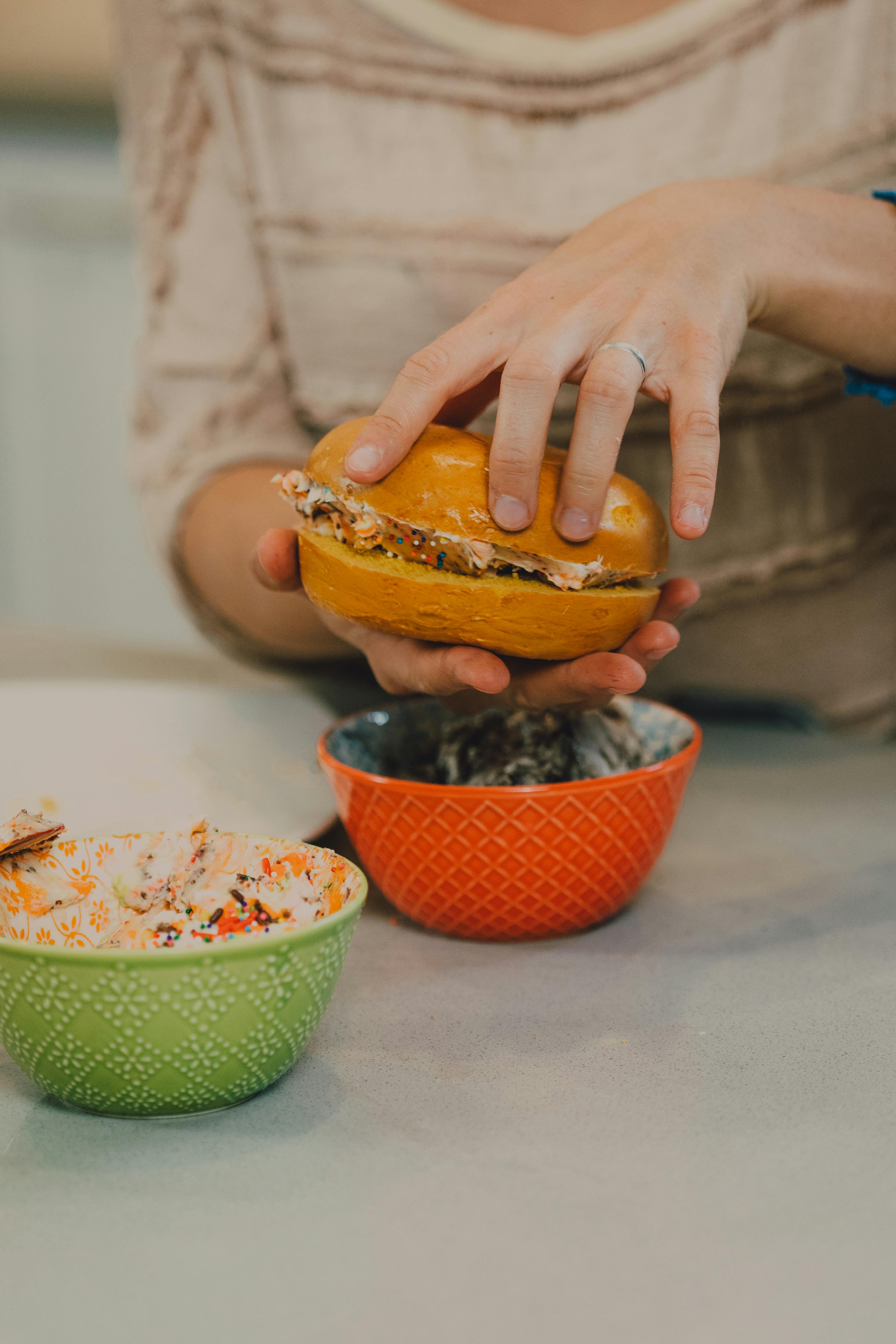 A Person Holding a Bagel · Free Stock Photo