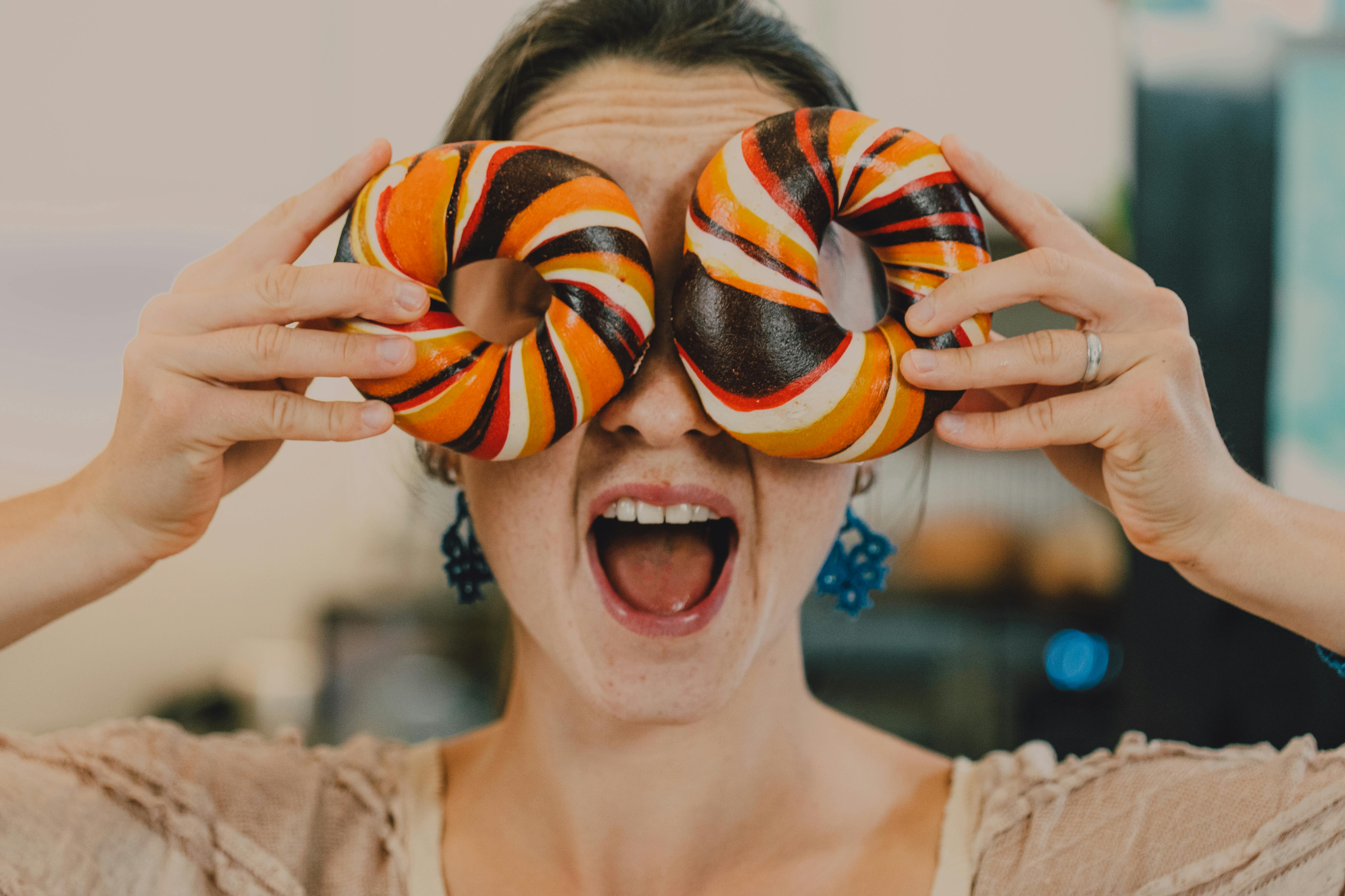 Close-Up Shot of a Person Holding Bagels · Free Stock Photo