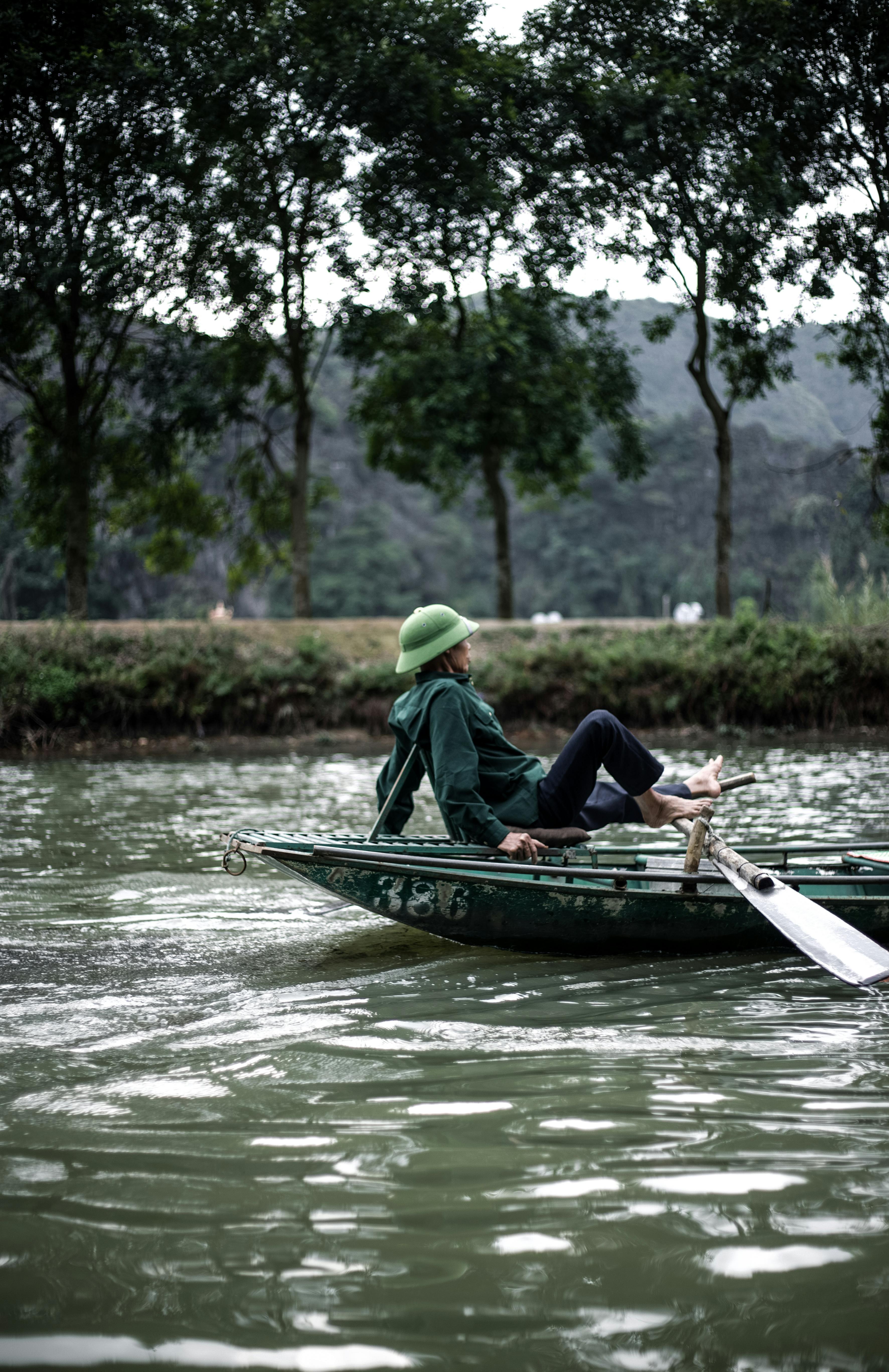 Man Riding on Boat Holding Brown Paddle · Free Stock Photo
