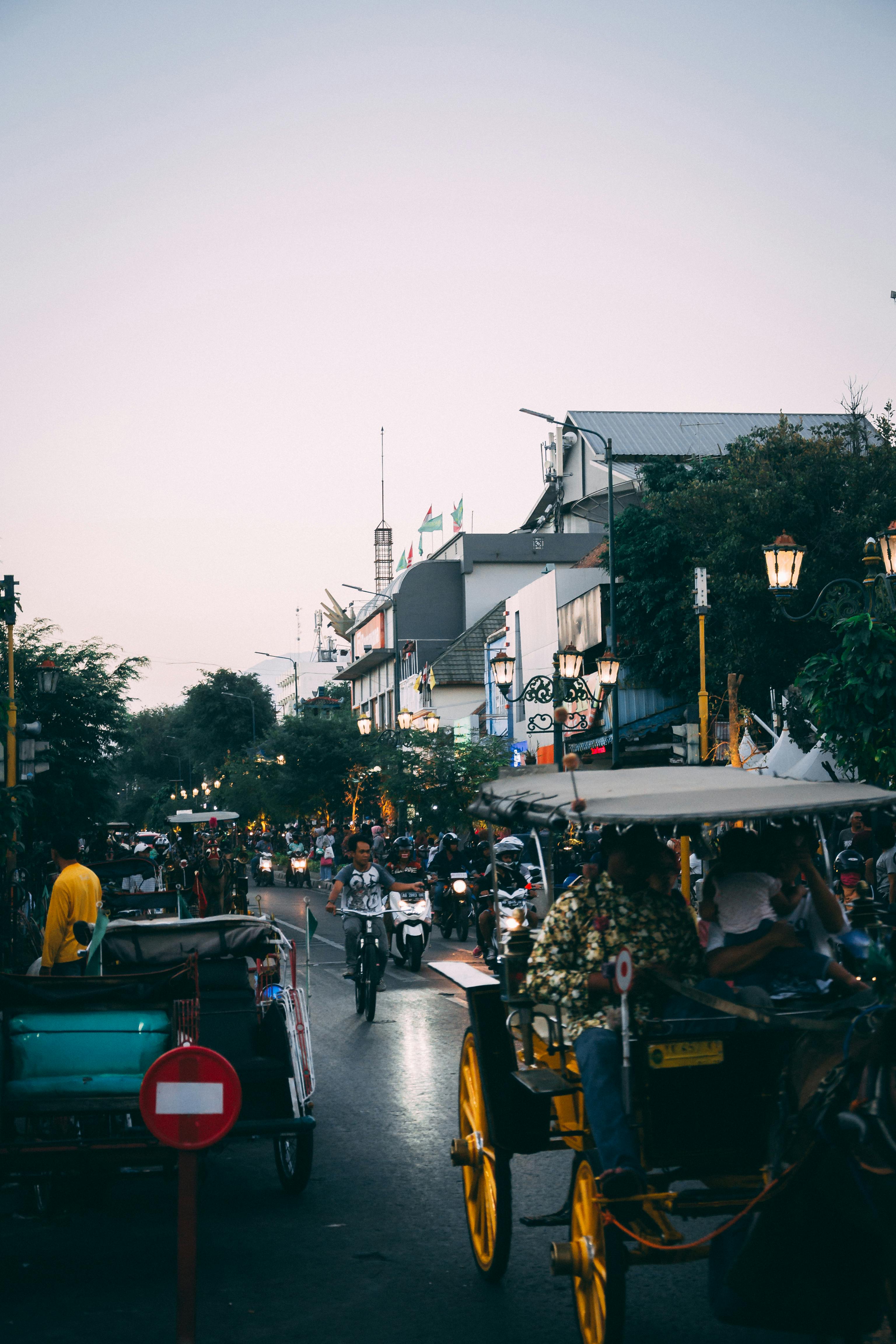 Person Pulling a Traditional Rickshaw on the Street · Free Stock Photo